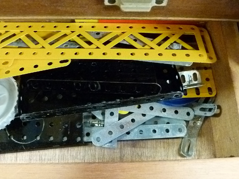 A collection of loose Meccano parts with instructions for outfits 1, 2/ ...