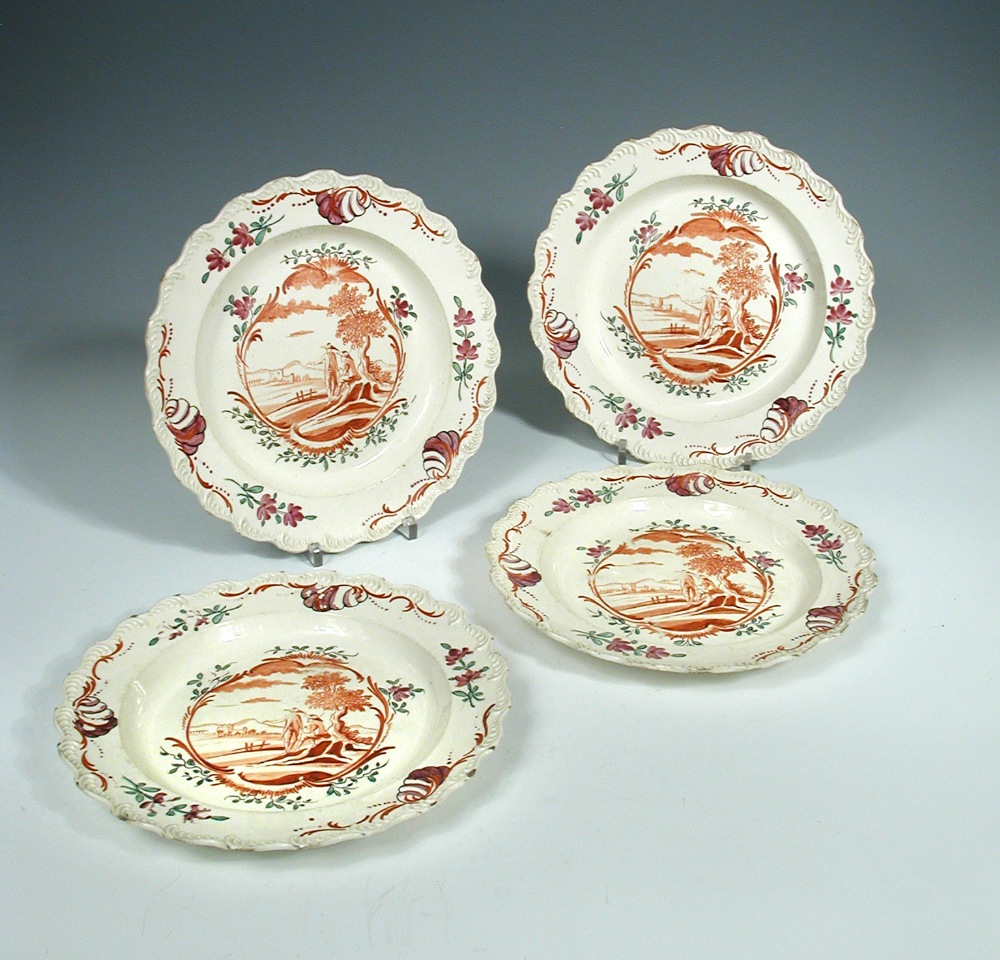 A set of four 18th century Leeds creamware plates, each painted to the ...