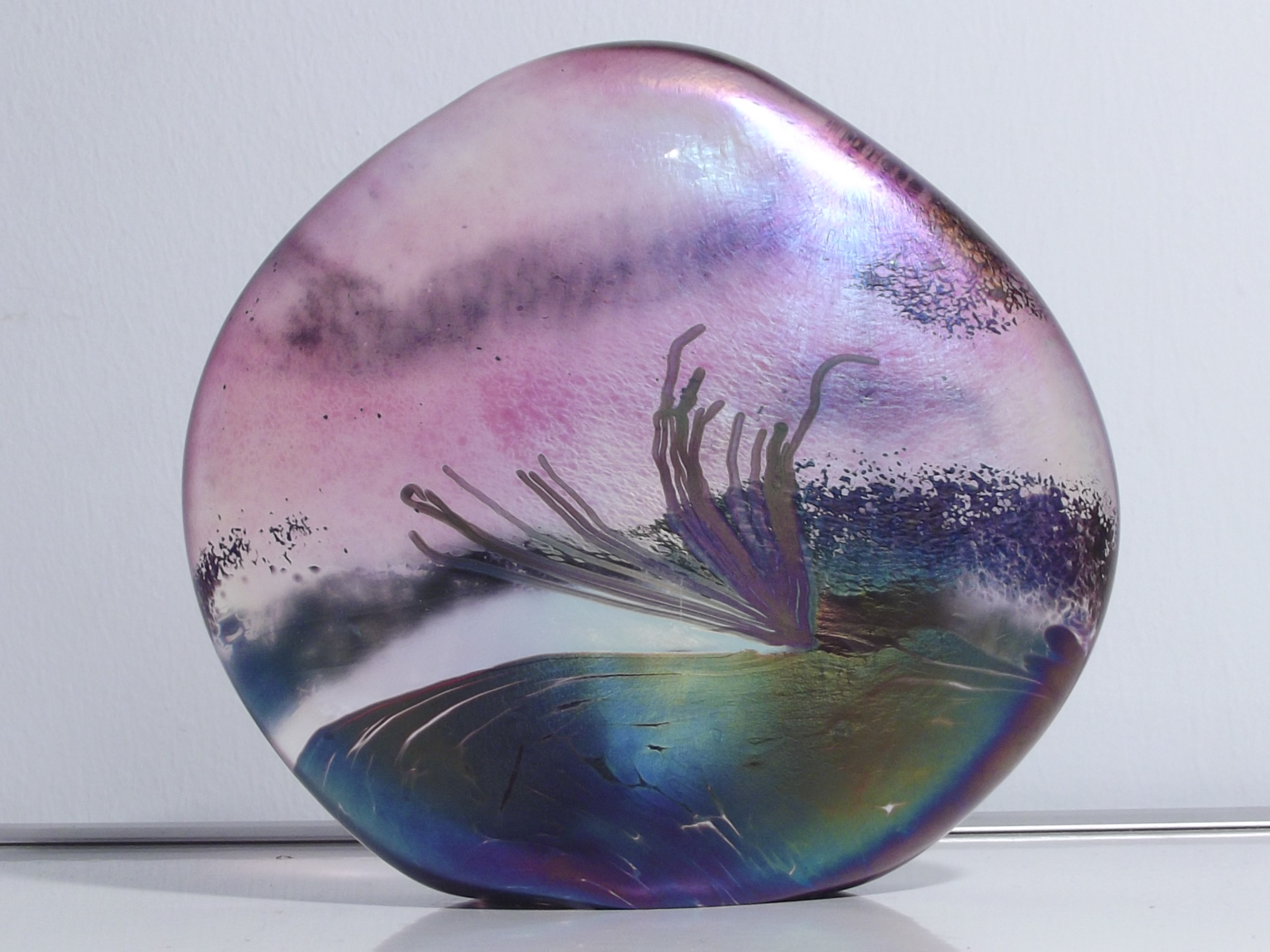 John Ditchfield iridescent glass paperweight, pebble form, with ...