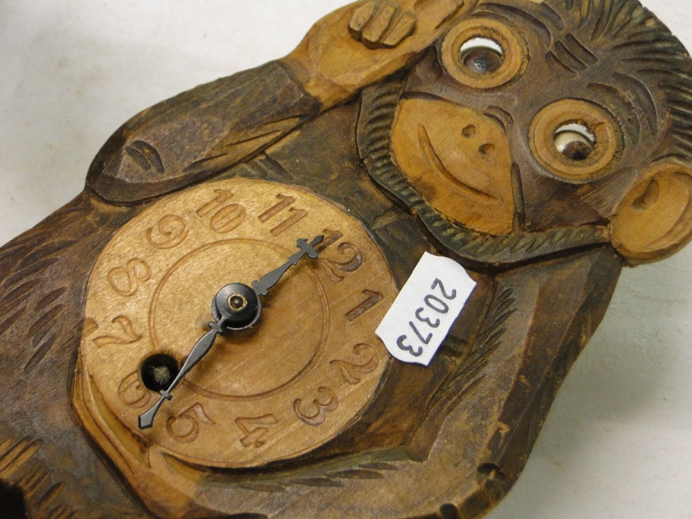 A Carved wood monkey figure clock with moving eyes, & a carved bear