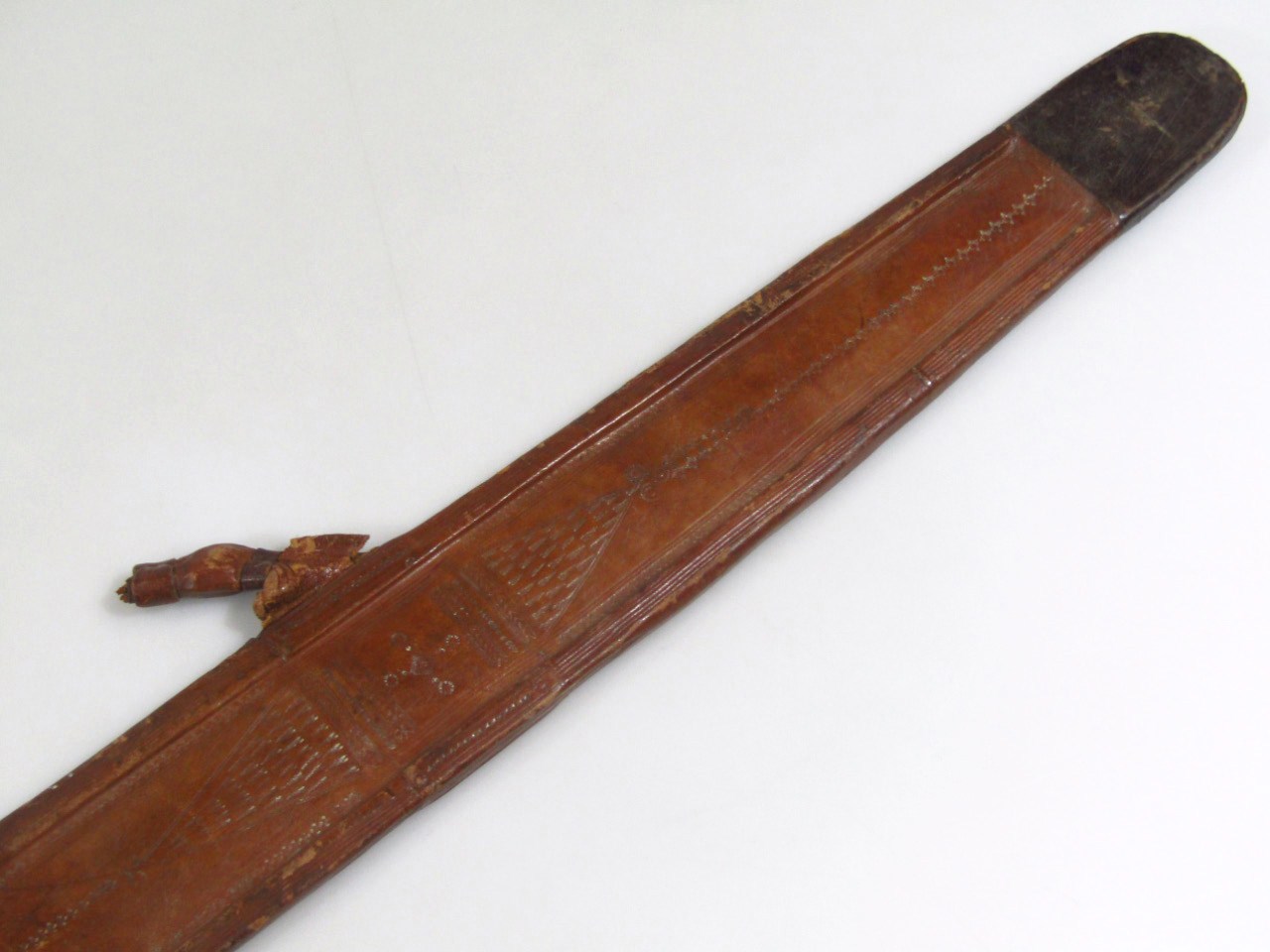 A Maori double edge sword, with leather grip handle and scabbard, with ...