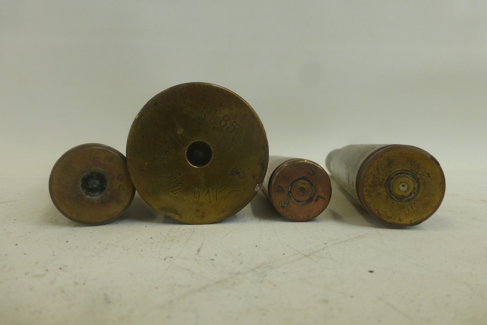 Three complete WWII dated inert cannon shells and a complete WWI ...