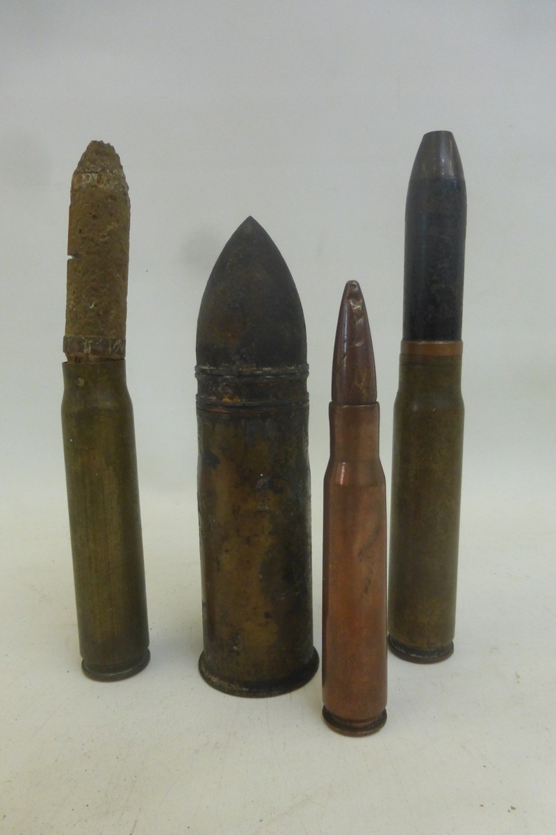 Three complete WWII dated inert cannon shells and a complete WWI ...
