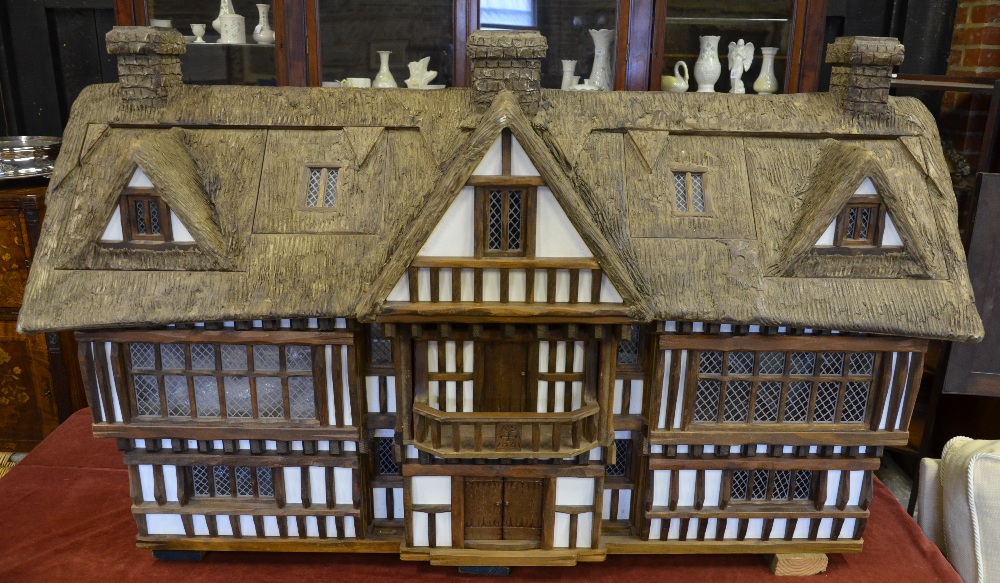 A large Robert Stubbs thatched dolls house of half-timbered design with ...