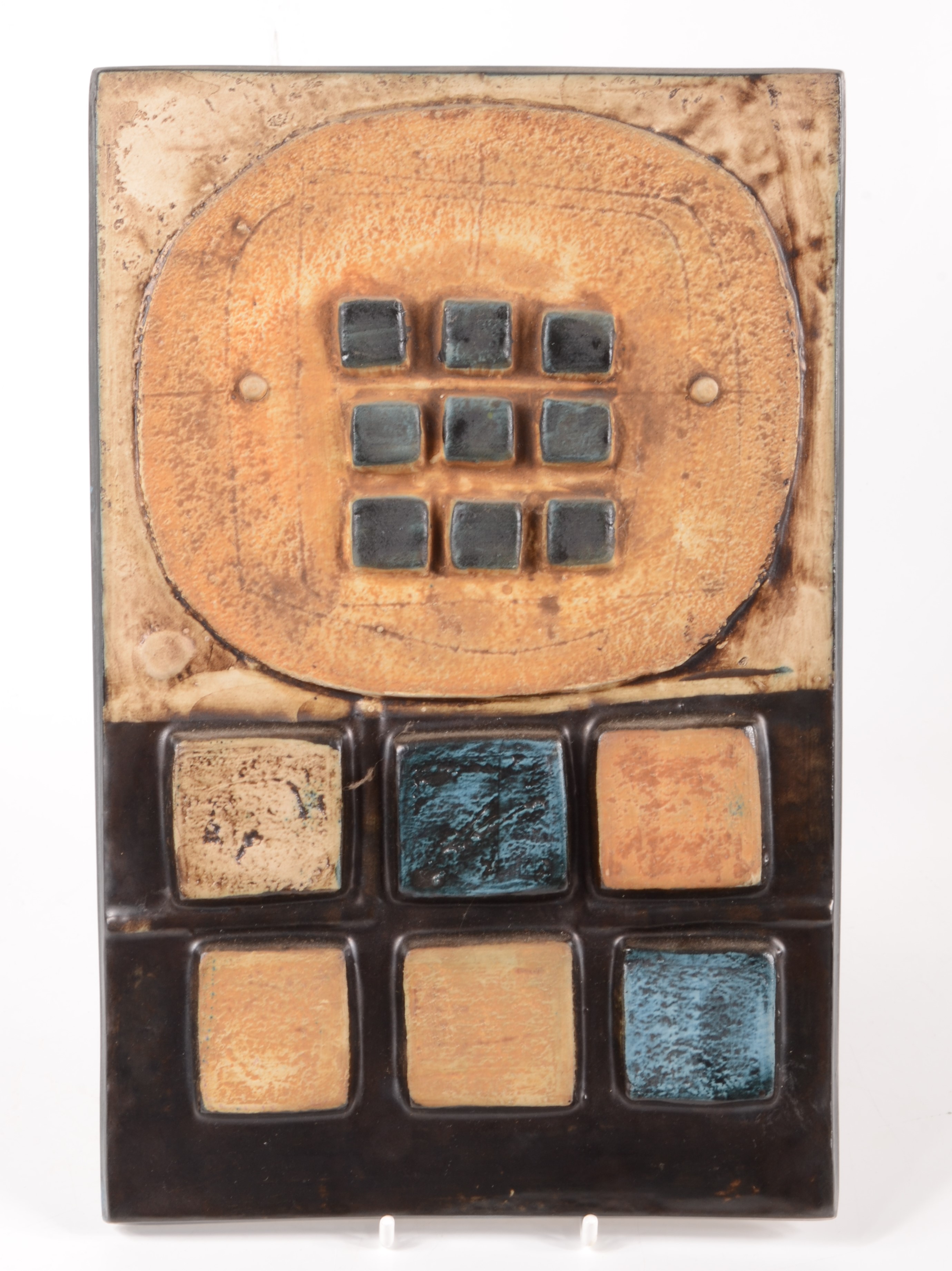 A Troika pottery wall plaque, with geometric designs and polychrome ...