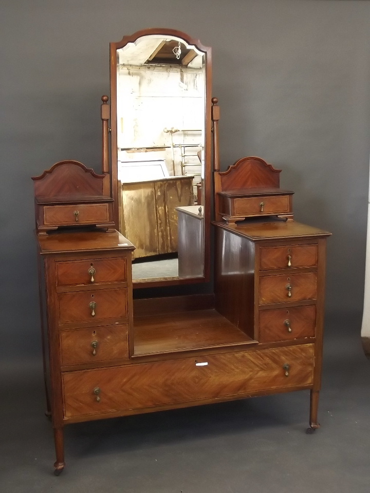 A 1920s mahogany dressing table with seven drawers and two upper ...
