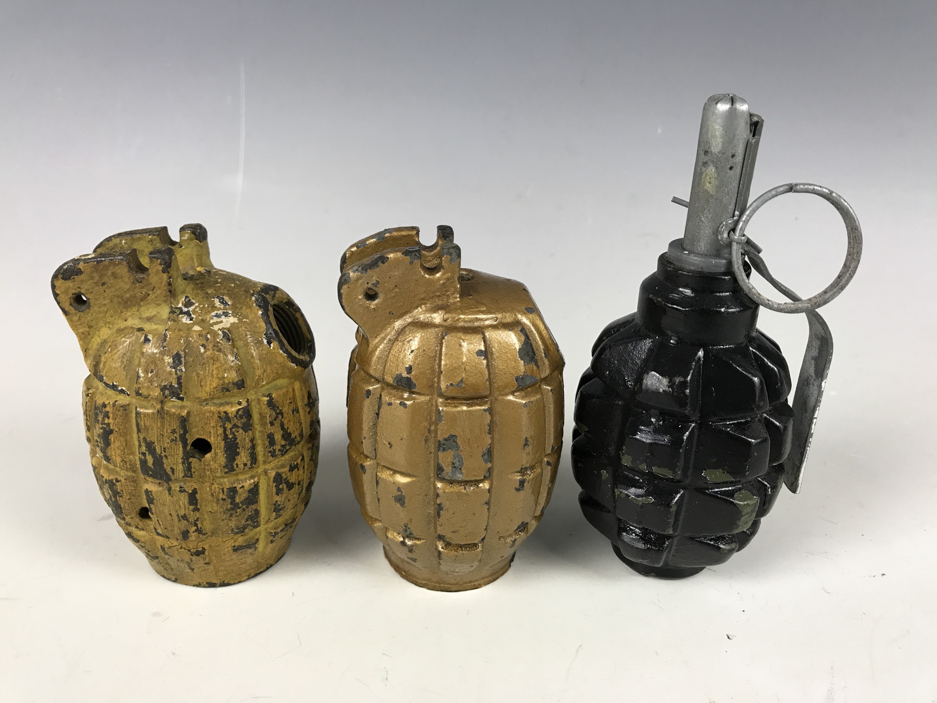 An inert Russian hand grenade together with two Mills bomb castings