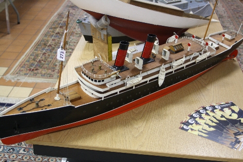 A POWERED MODEL OF A TWO FUNNEL OCEAN LINER, red and black livery ...