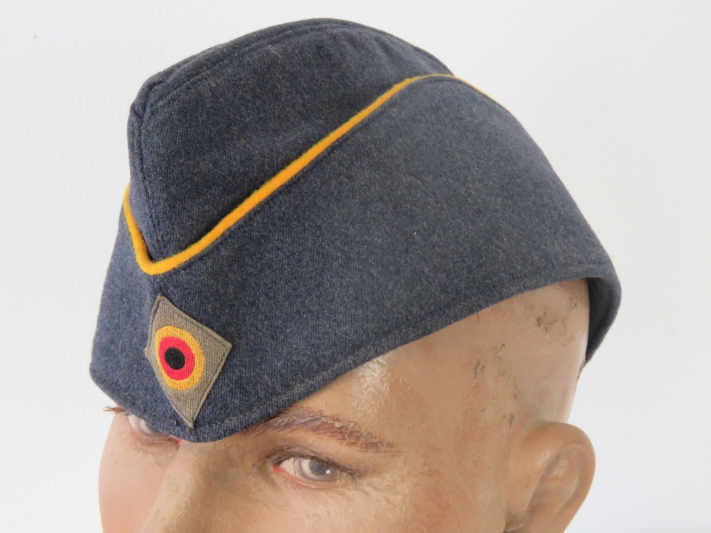 An East German blue cloth side cap having label within dated 1963.