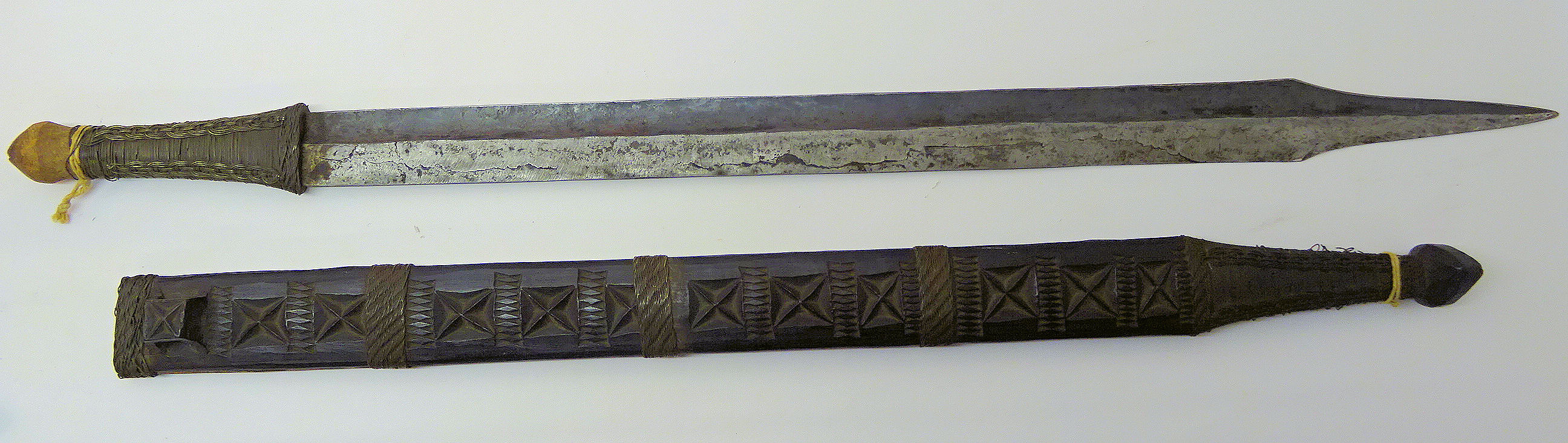 A Shona, Zimbabwe short Sword with wooden scabbard, hatch carved and ...