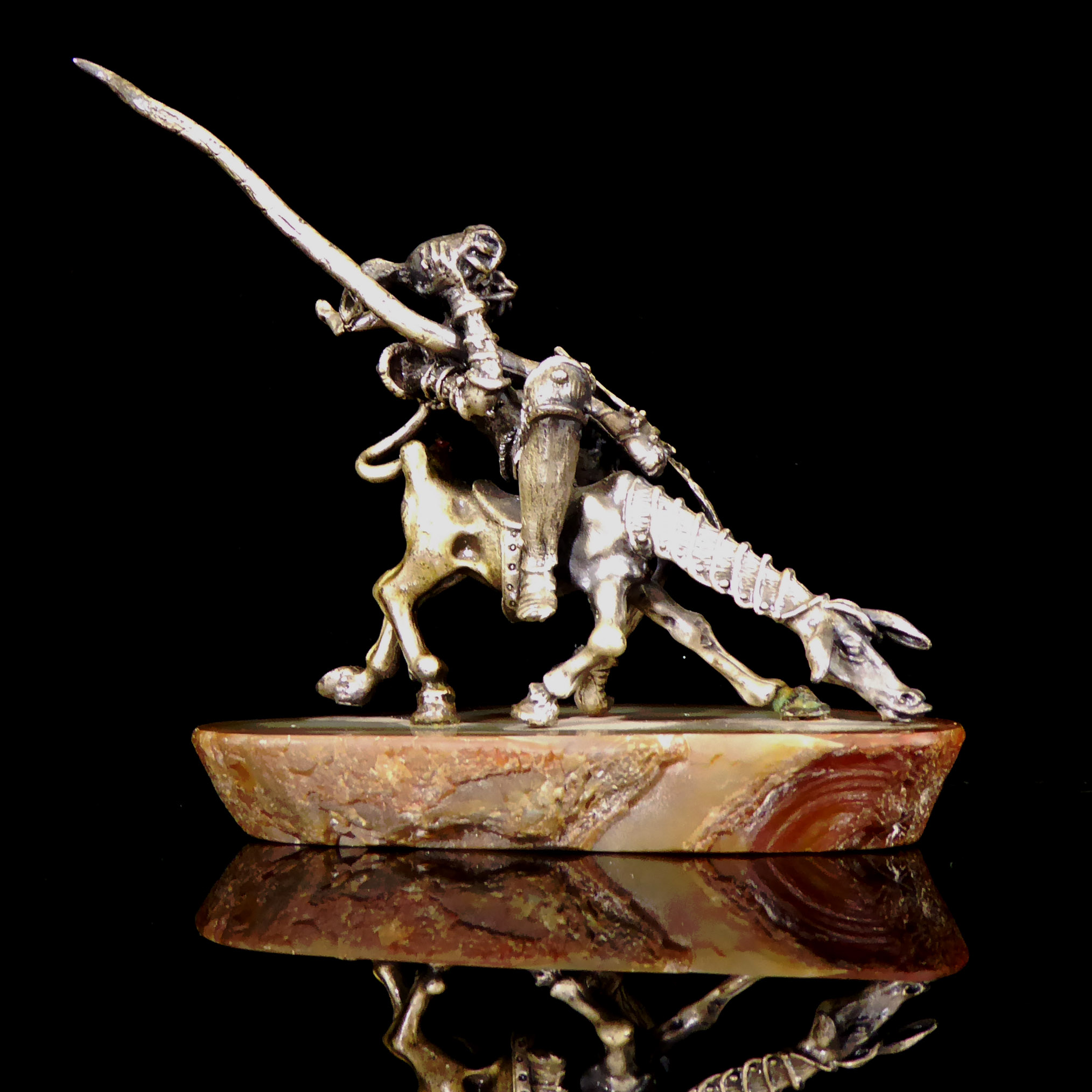 A 20TH CENTURY ITALIAN SILVER AND ONYX MODEL OF DON QUIXOTE Wearing ...