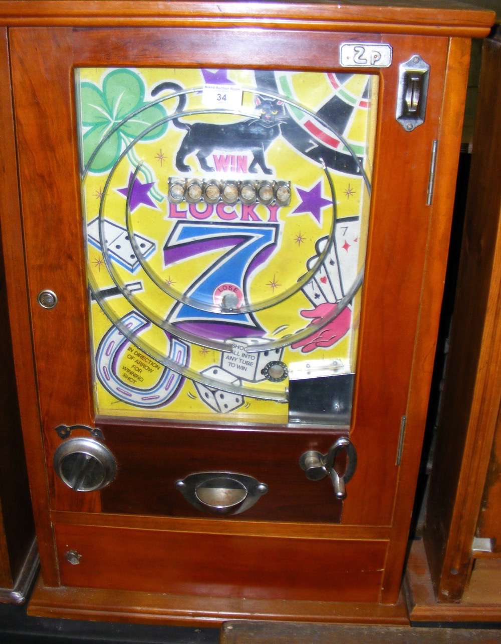 A 2p coin in the slot "Lucky 7" pinball type amusement arcade machine