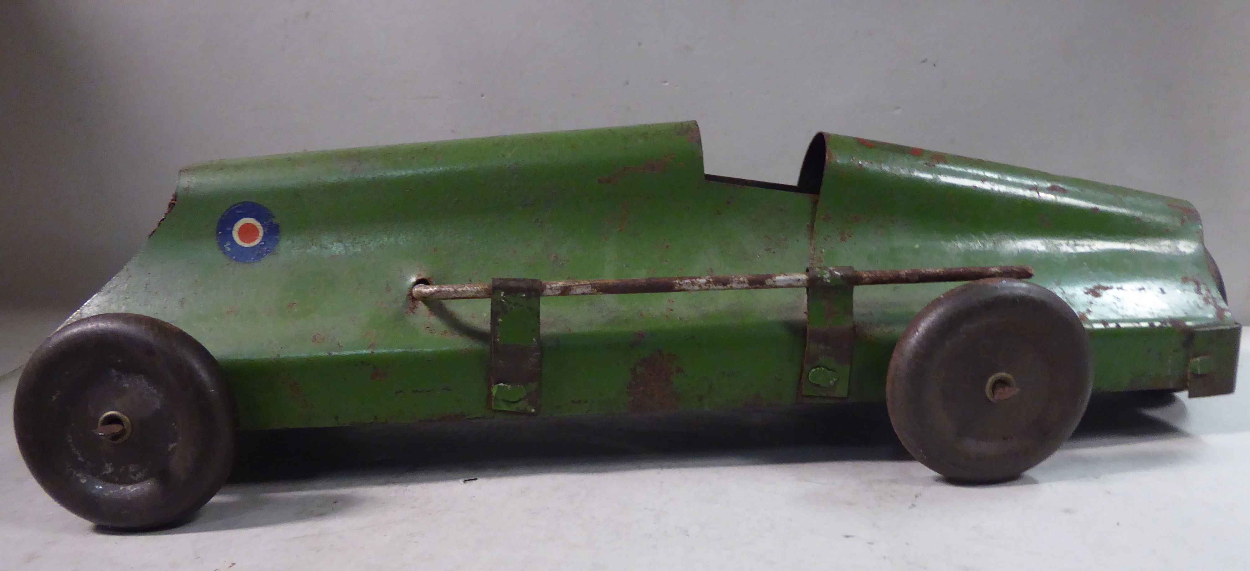 A 1920s scratch built green painted tinplate model racing car with ...