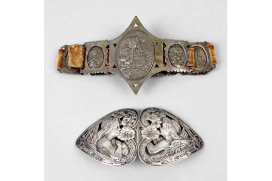 An Art Nouveau silver two part buckle, each section of pierced heart ...