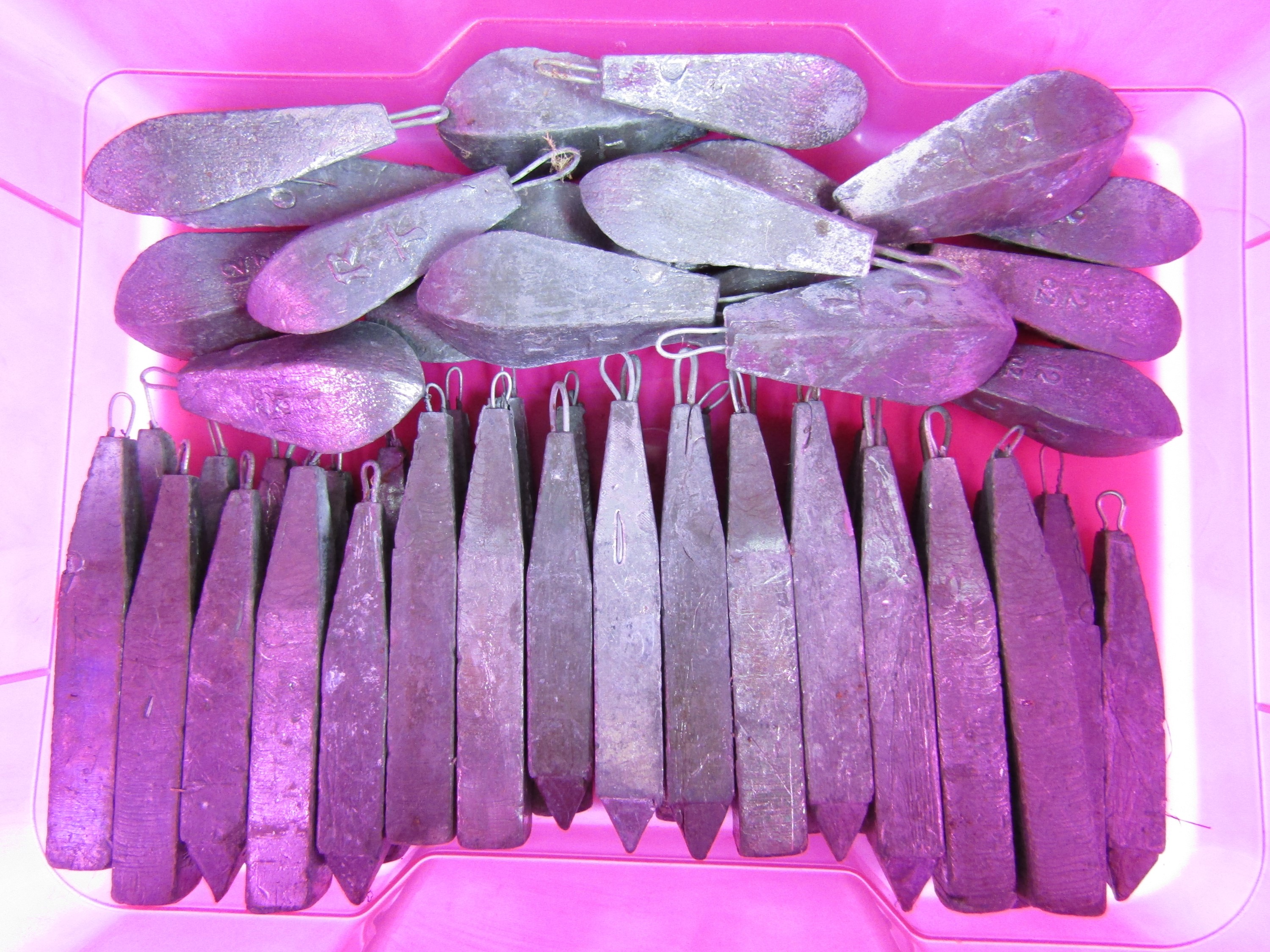 Fifty deep sea fishing weights - 9, 10, 12 and 16 oz