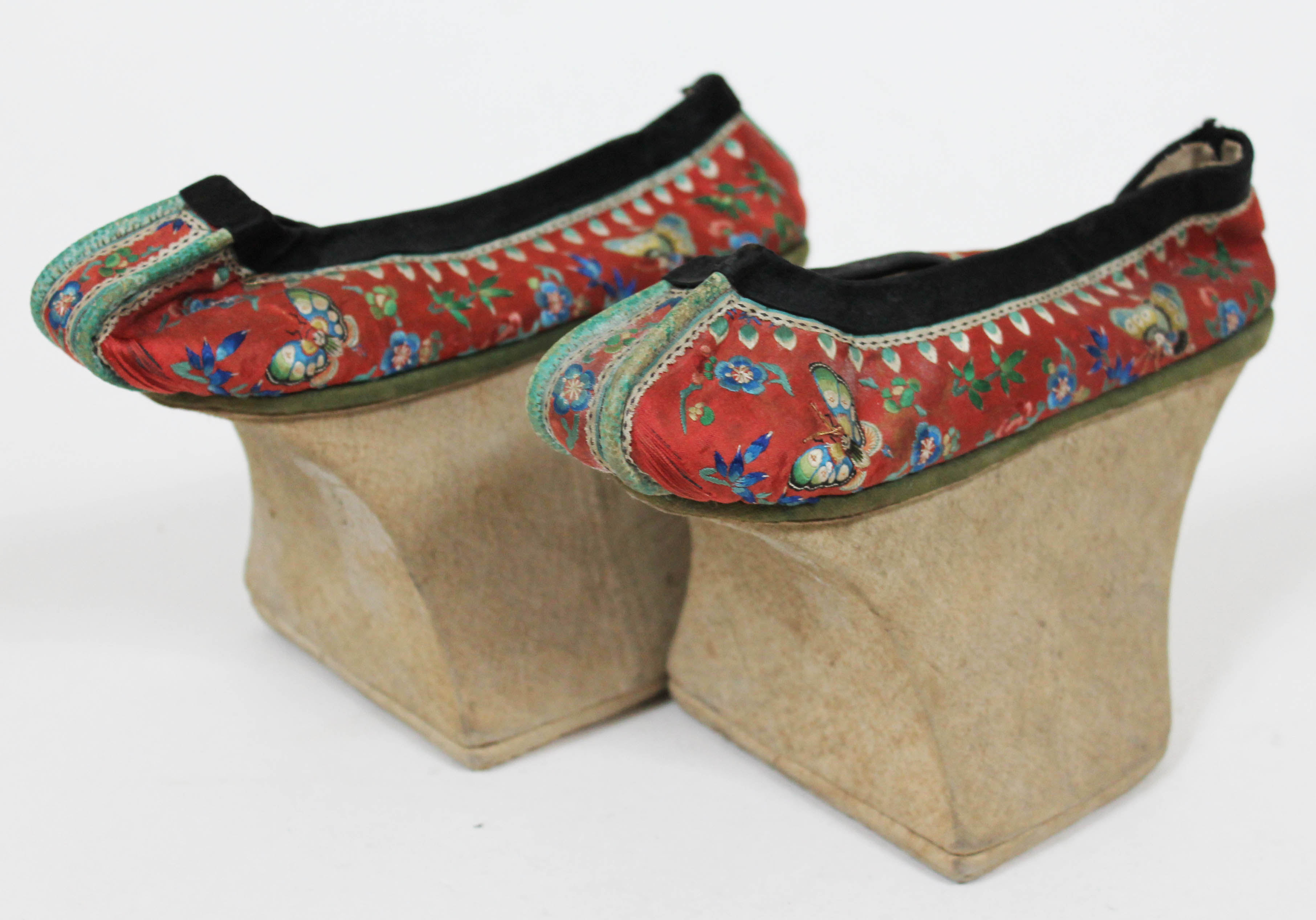 A pair of Chinese Manchu silk embroidered platform shoes.