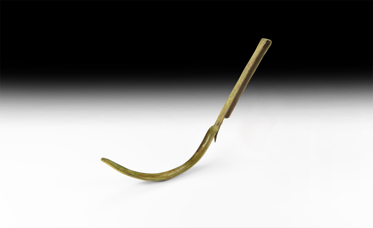 1st-3rd century AD. A bronze strigil with concave sharply-curved ...