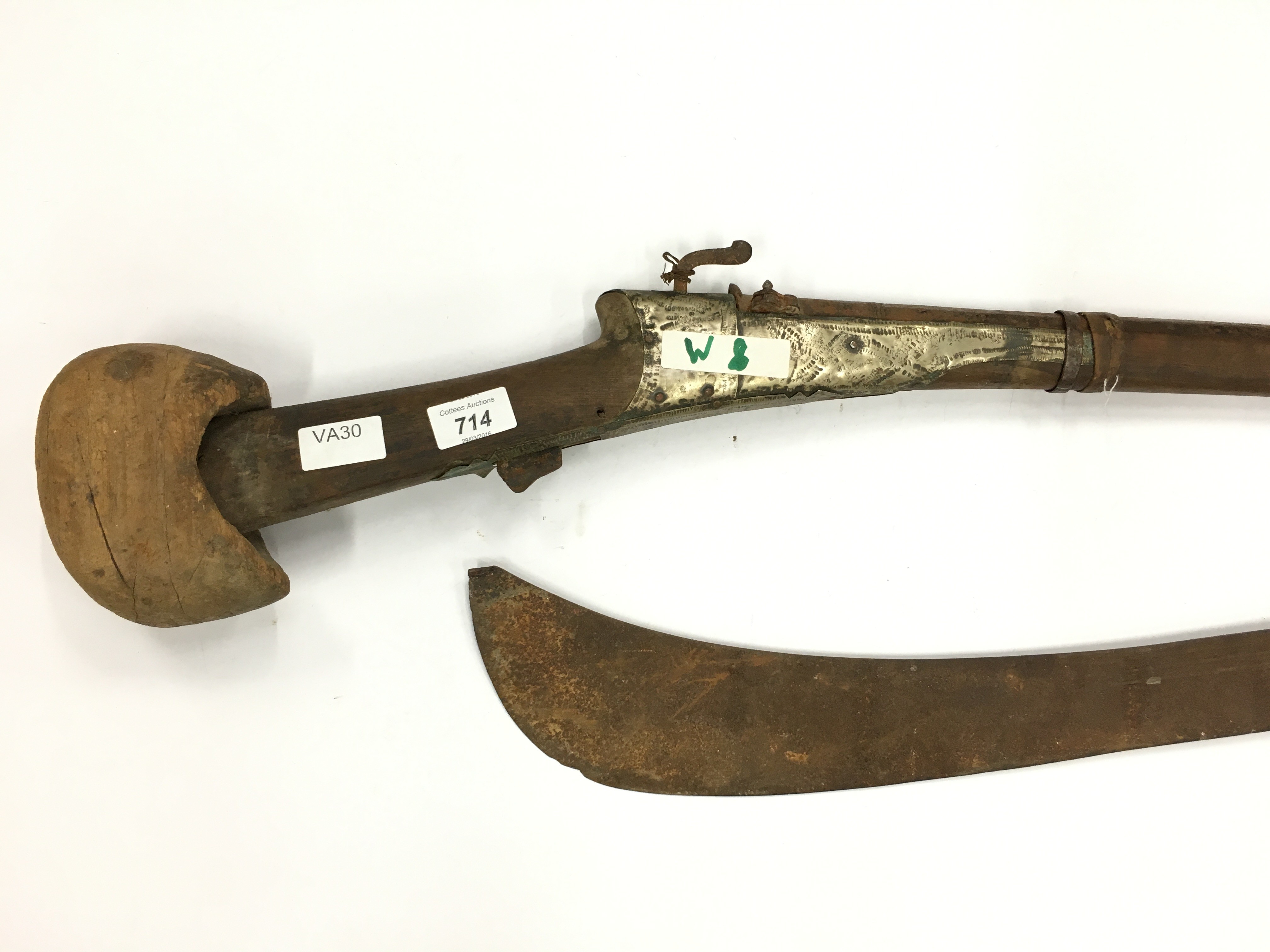 A horn handled machete together with an Arabian Arab Matchlock musket ...