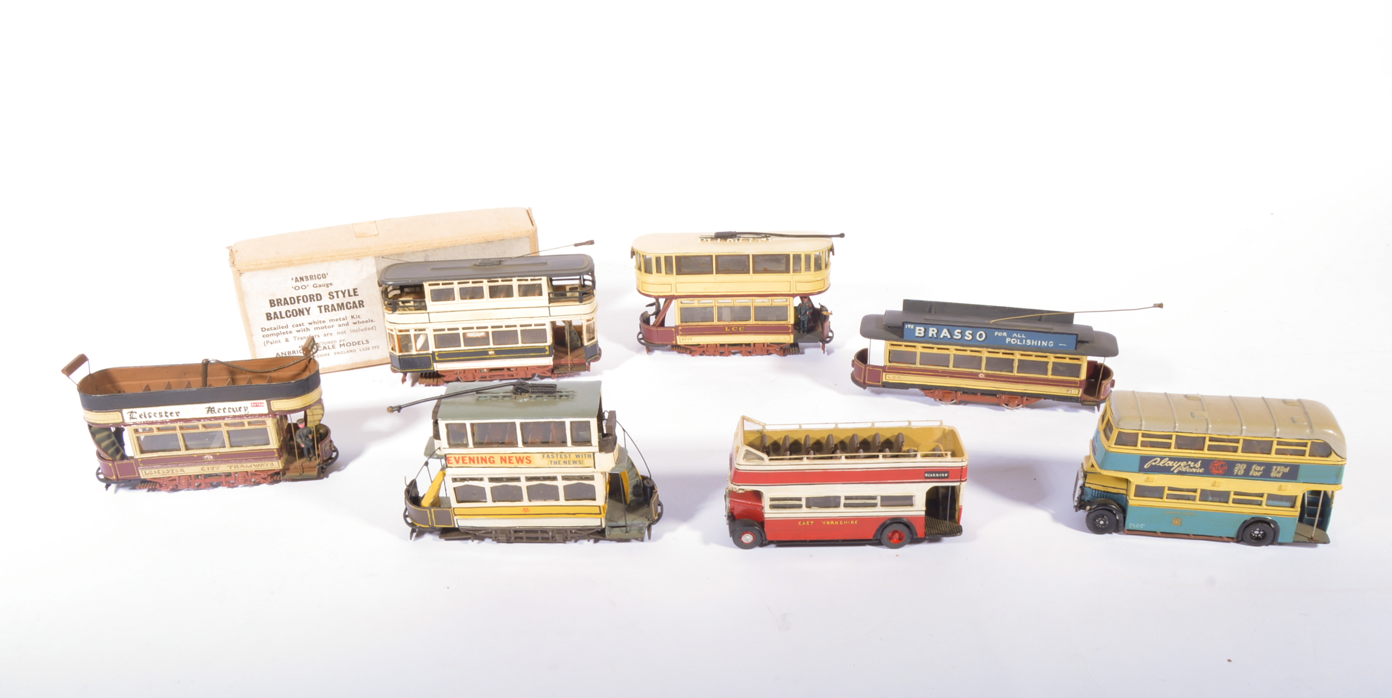 Two metal kit built 00 gauge motorized trams, along with five un ...