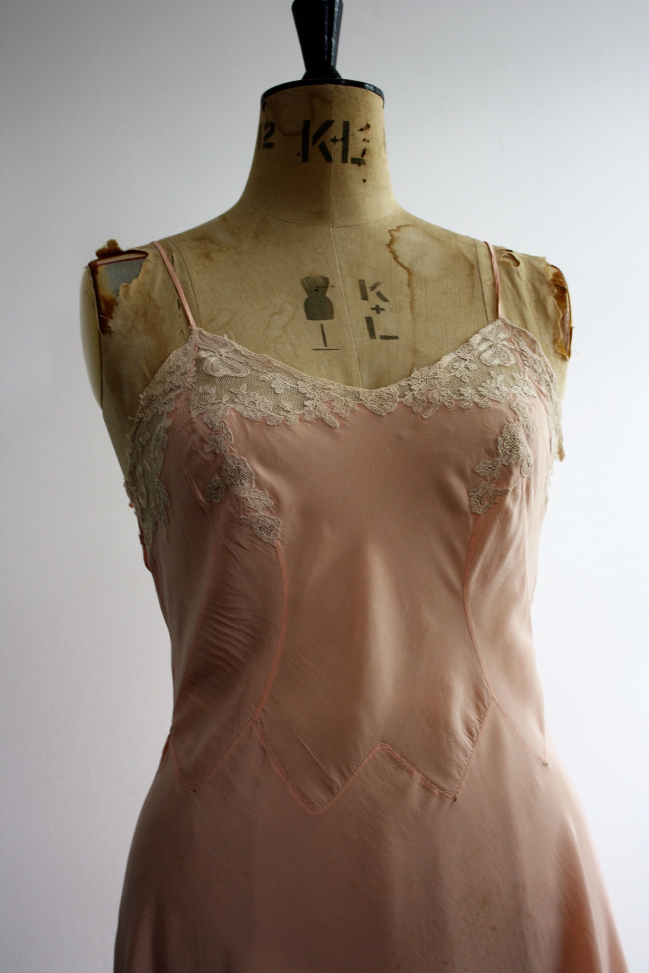 A trio of 1940s slips. A waist slip in soft pink rayon with lace trim ...