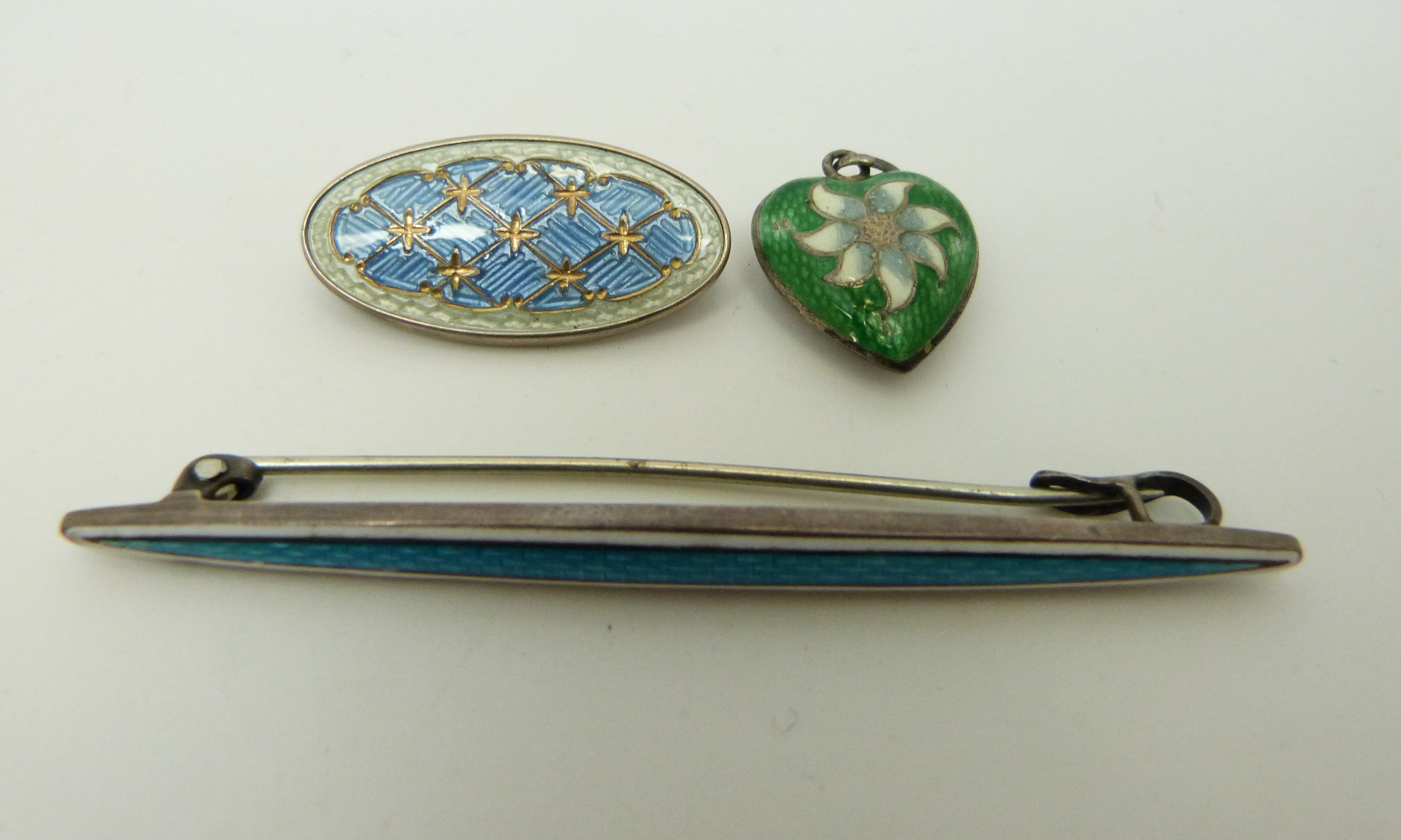 A hallmarked silver brooch, further silver brooch and a silver heart ...