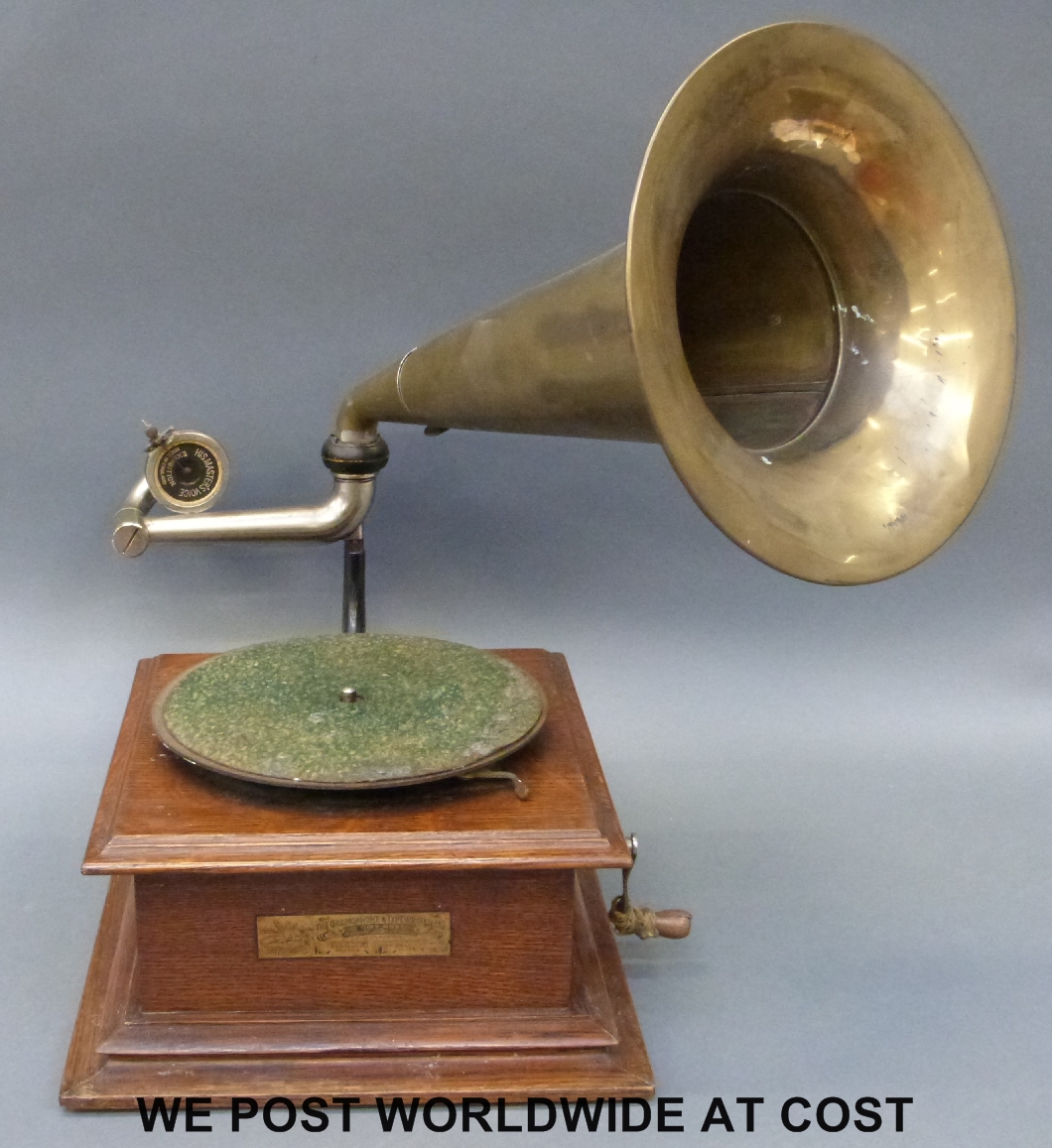 A vintage gramophone with brass horn, with label for The Gramophone and ...