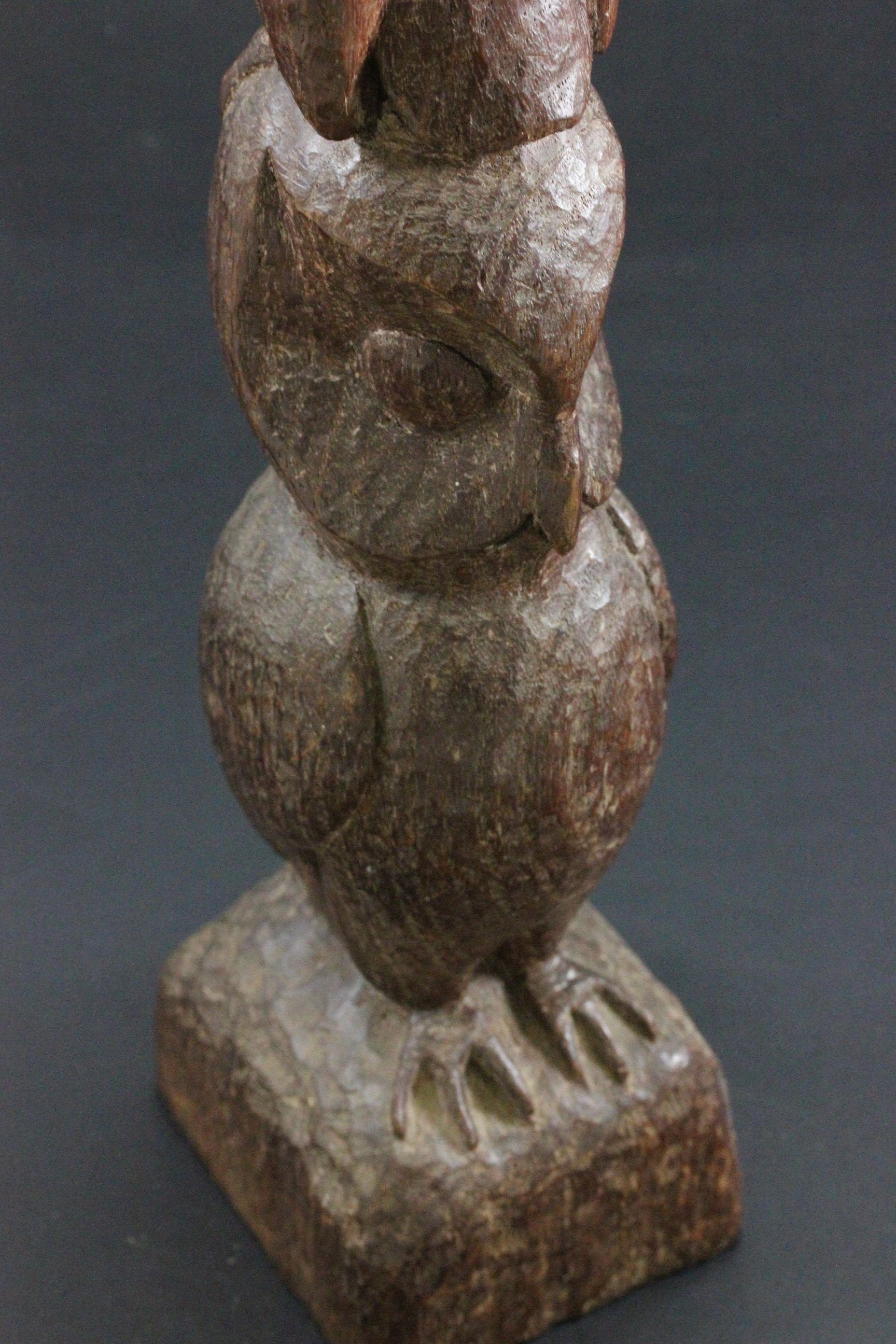 Carved wooden owls on totem pole style design