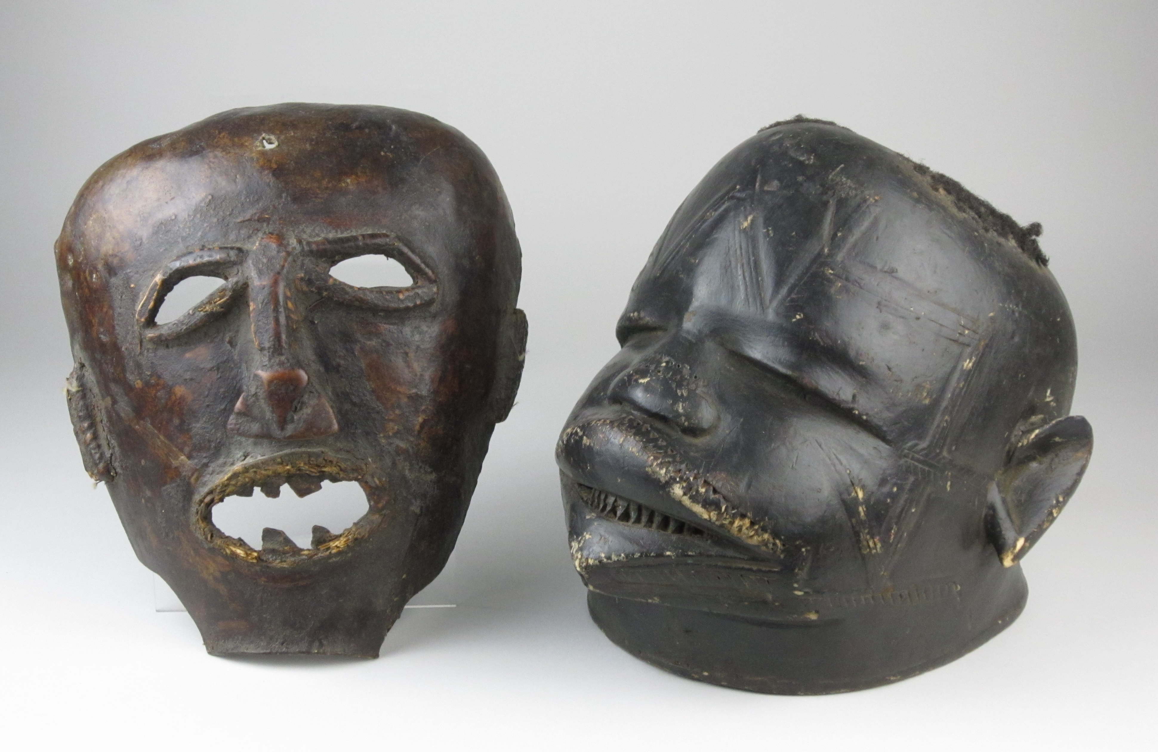 Two Tanzanian Masks, comprising a striking Haya mask, the leather face ...