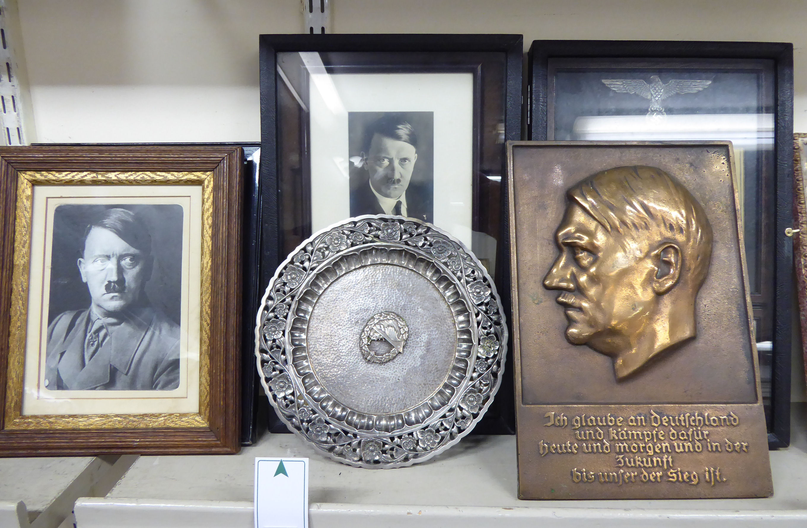 Reproduction World War II German collectables, viz. a gilt metal Hitler ...