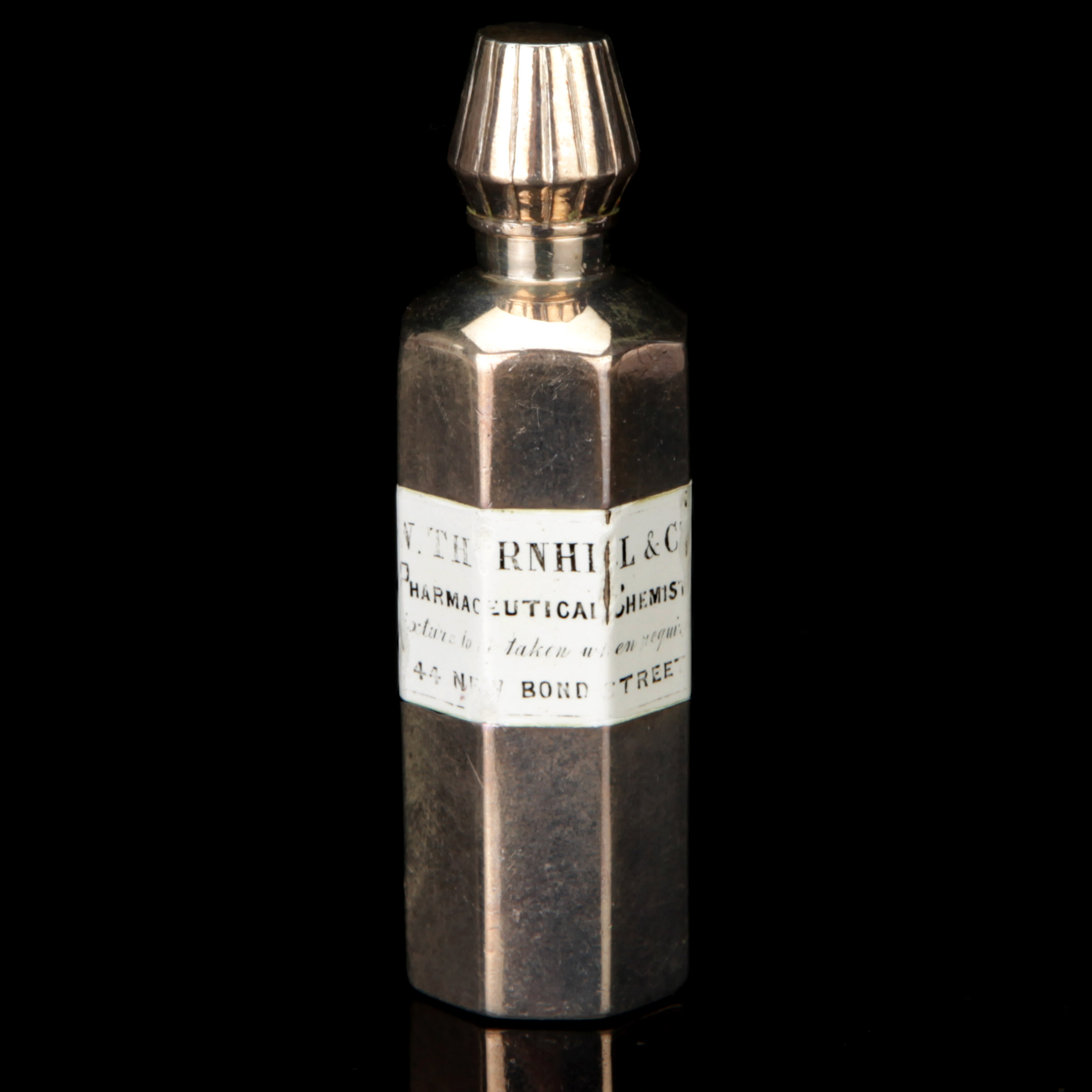 A Silver Medicine Bottle, with enamel label reading ‘W Thornhill & Co ...