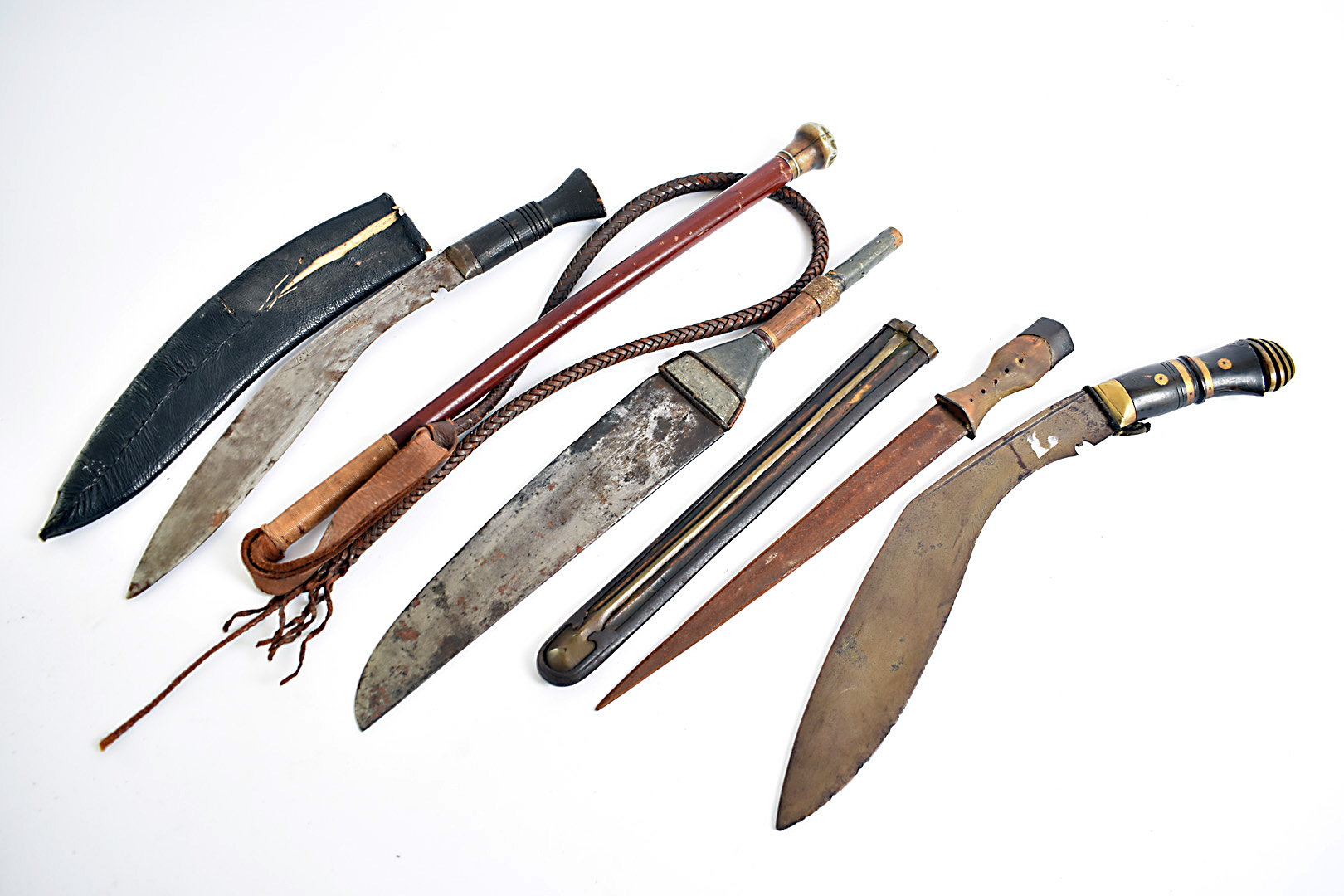 Two Middle Eastern Kukri knives, one having wooden handle with brass ...