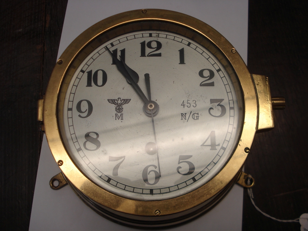 A Third Reich period Kriegsmarine bulkhead clock:, the silvered dial ...