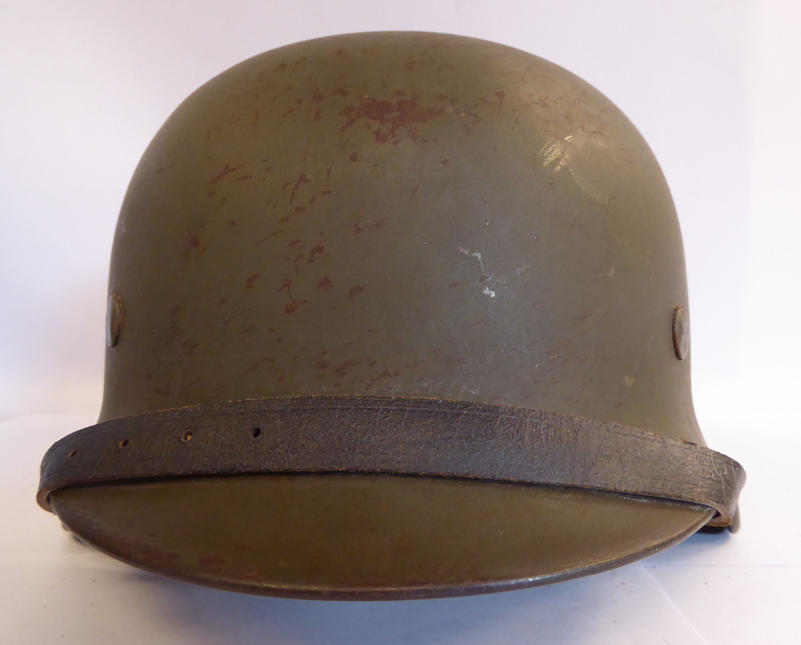 A World War II German Army steel helmet, in green with two decals