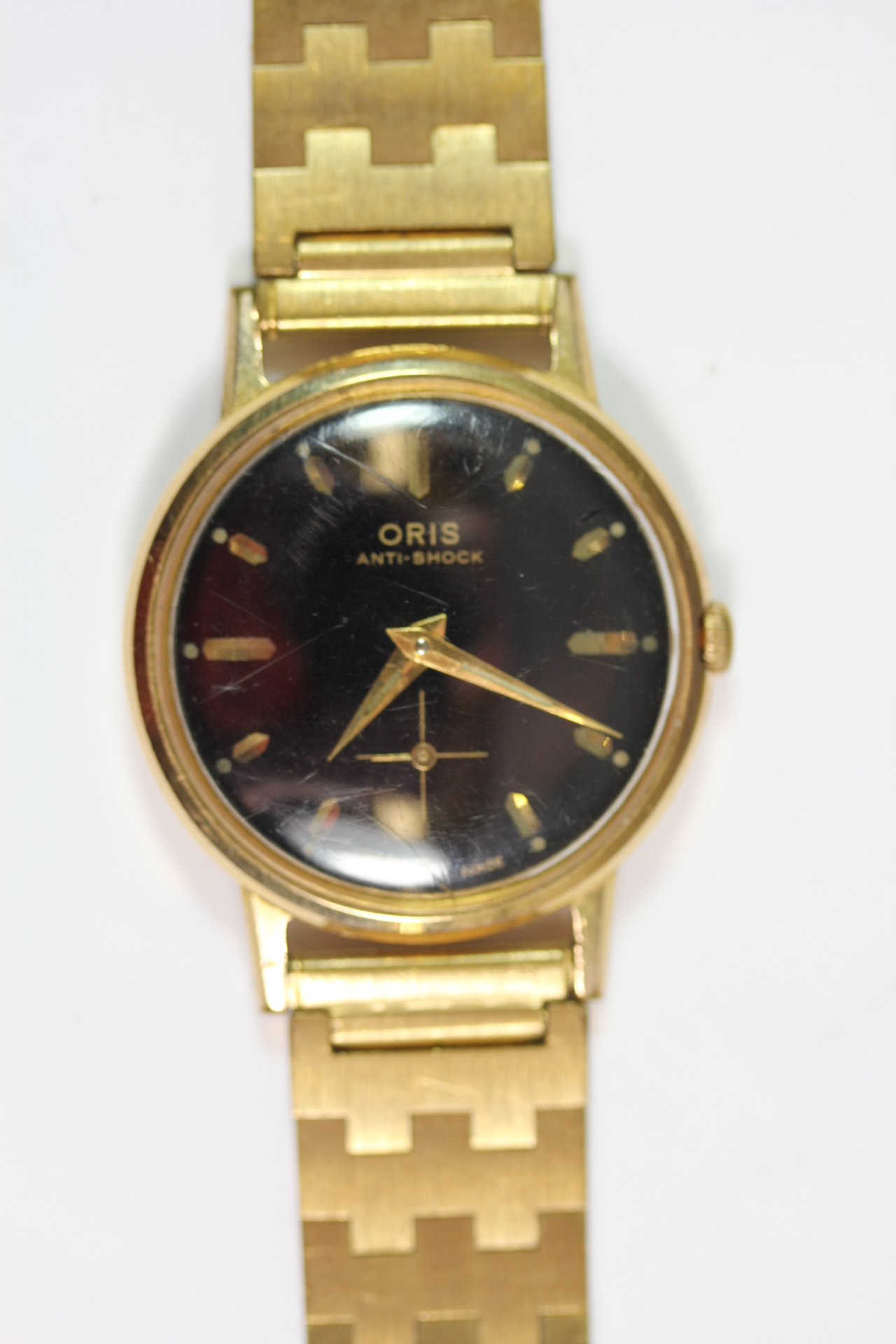 A black face Oris wrist watch.