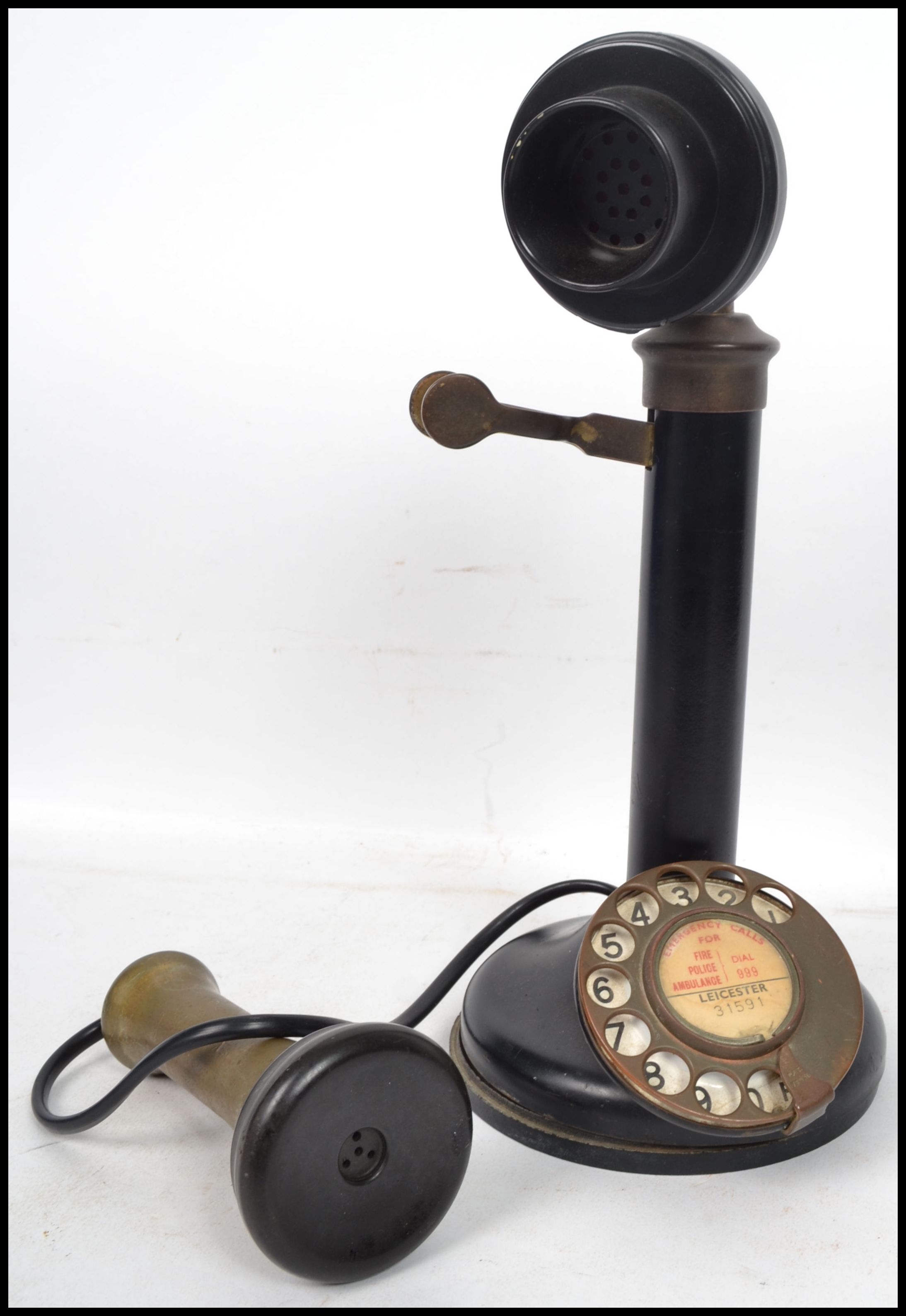 A vintage 20th century ring dial stick telephone having a brass ...