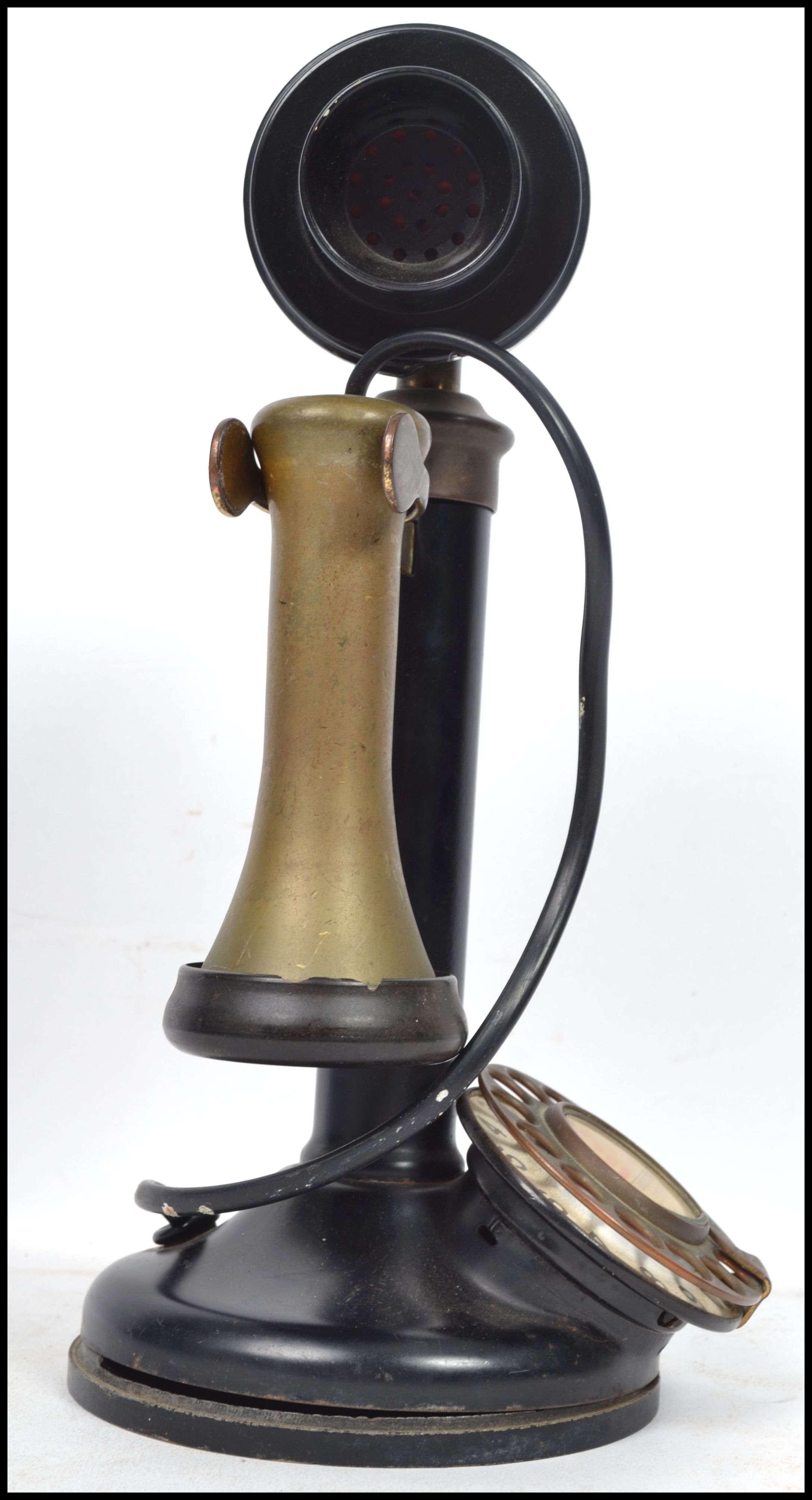A vintage 20th century ring dial stick telephone having a brass ...