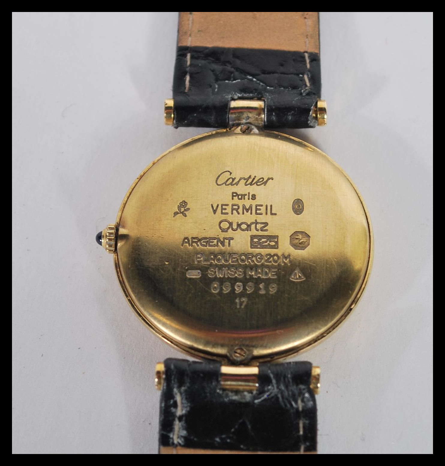 A vintage Must de Cartier wrist watch having a round face with roman ...