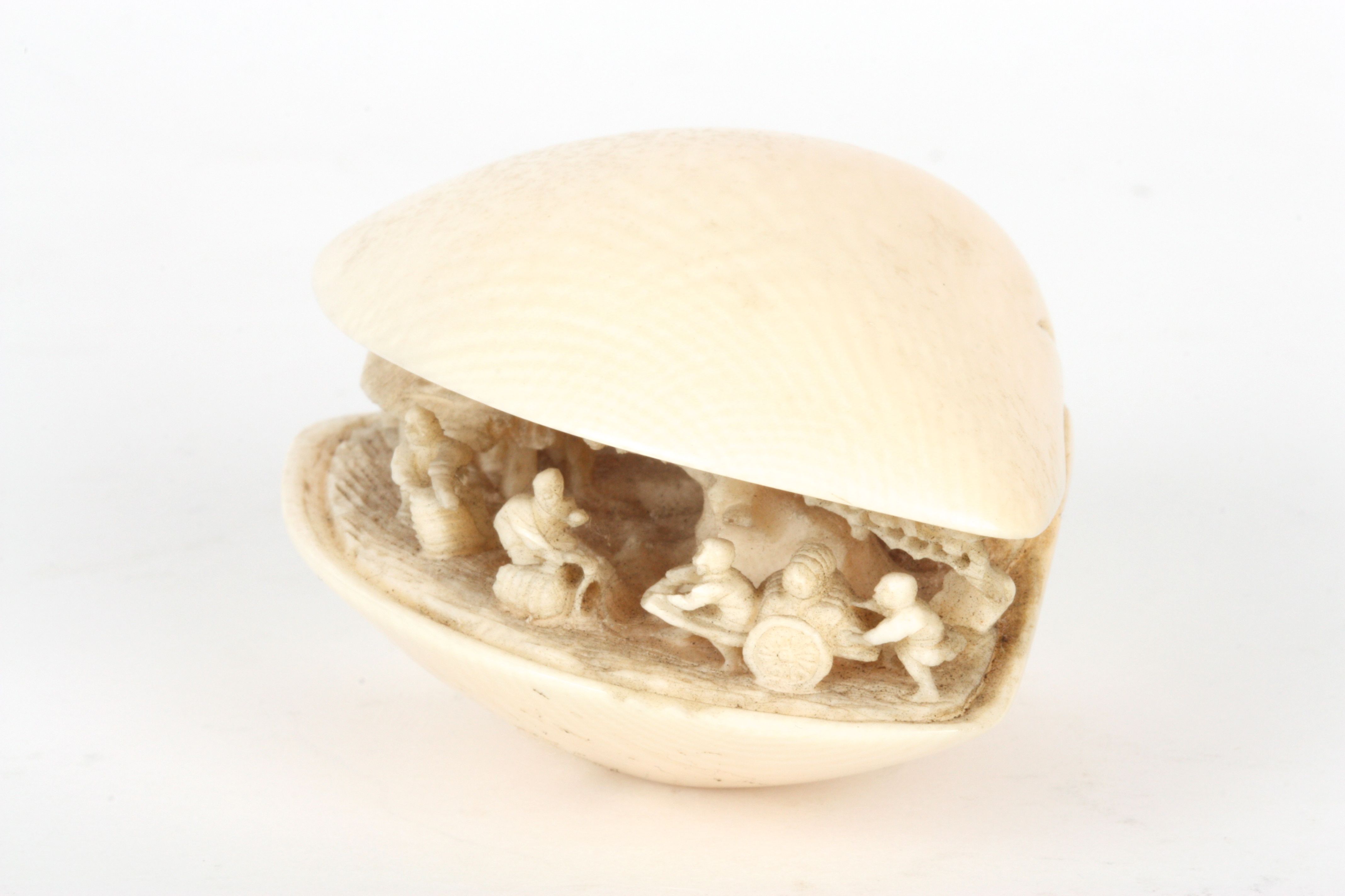 An early 20th century Chinese carved ivory clam shell carved with a ...