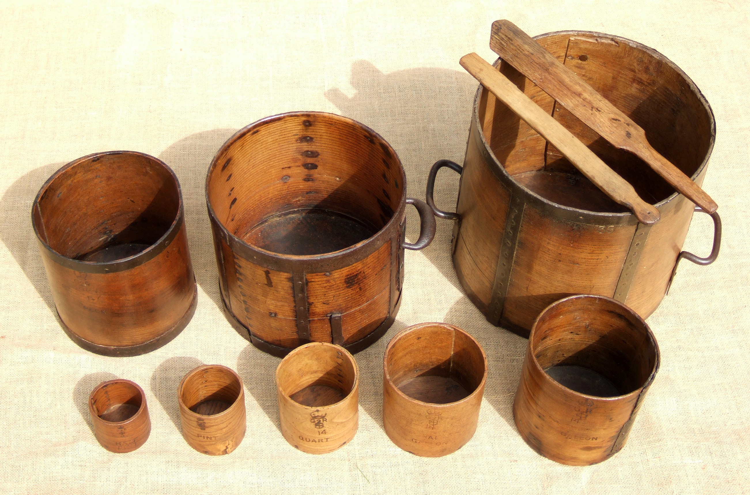 EIGHT BENTWOOD DRY MEASURES & TWO FLAT STRIKES. George II measures ...