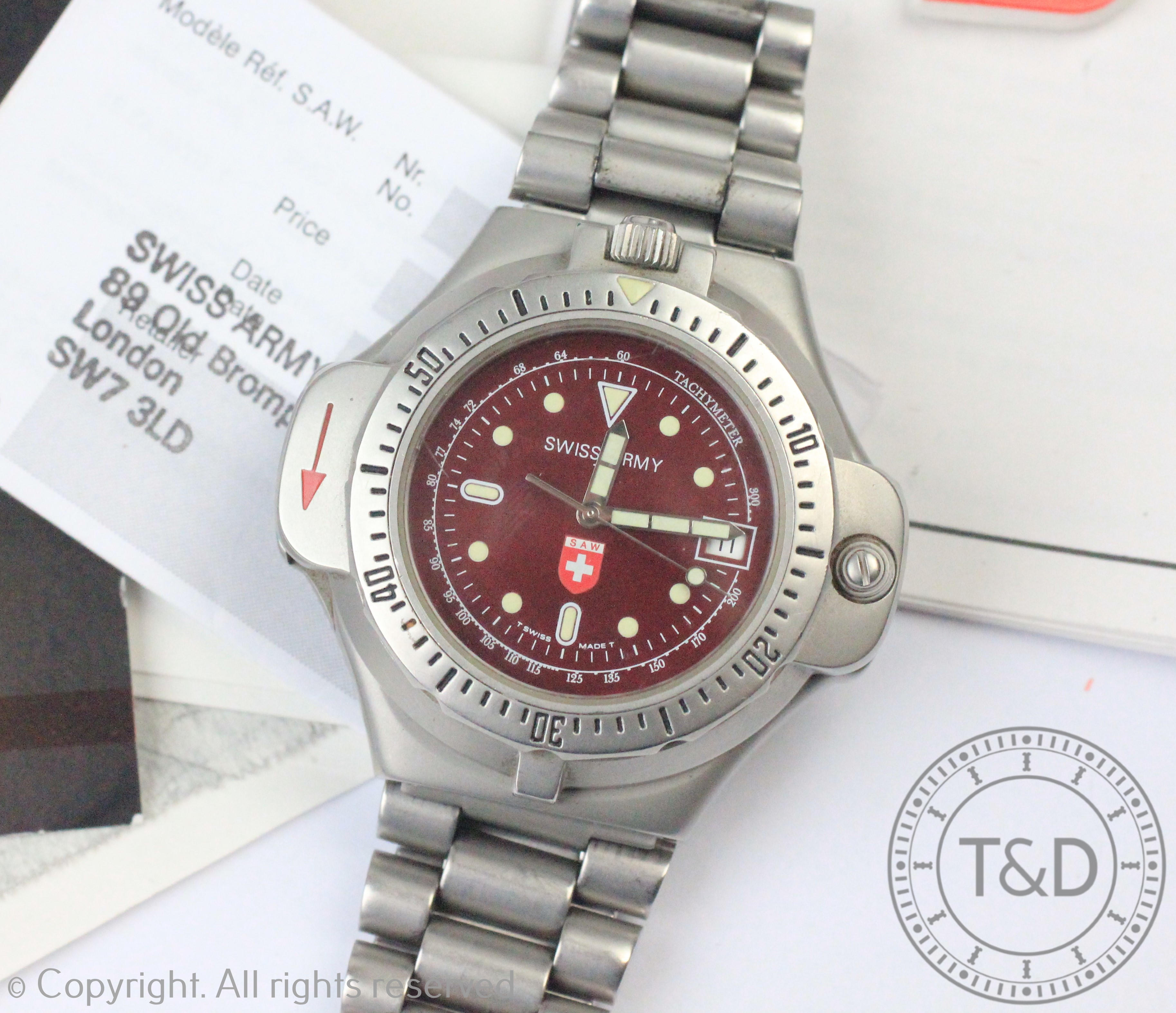 A Swiss Army compass watch, the stainless steel case enclosing claret ...