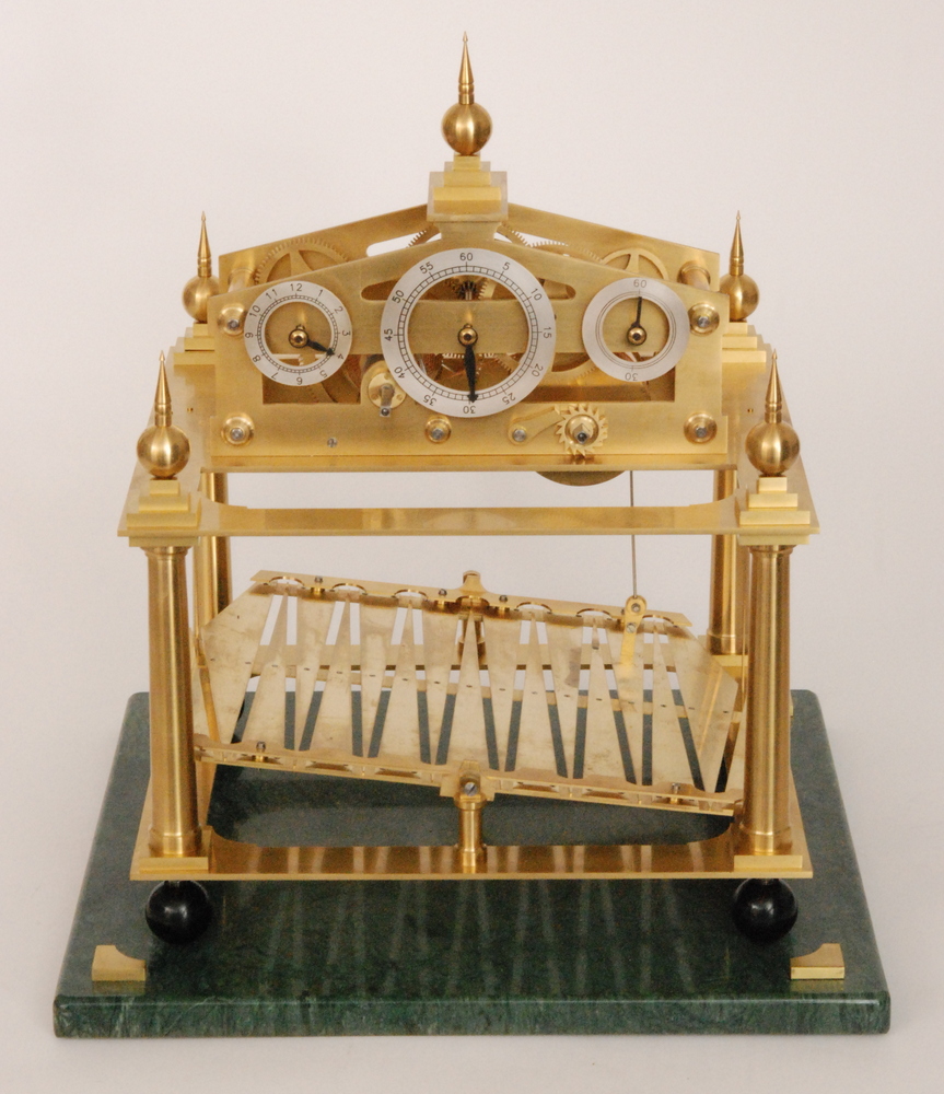 A replica brass Congreve rolling ball clock with three silvered dials ...