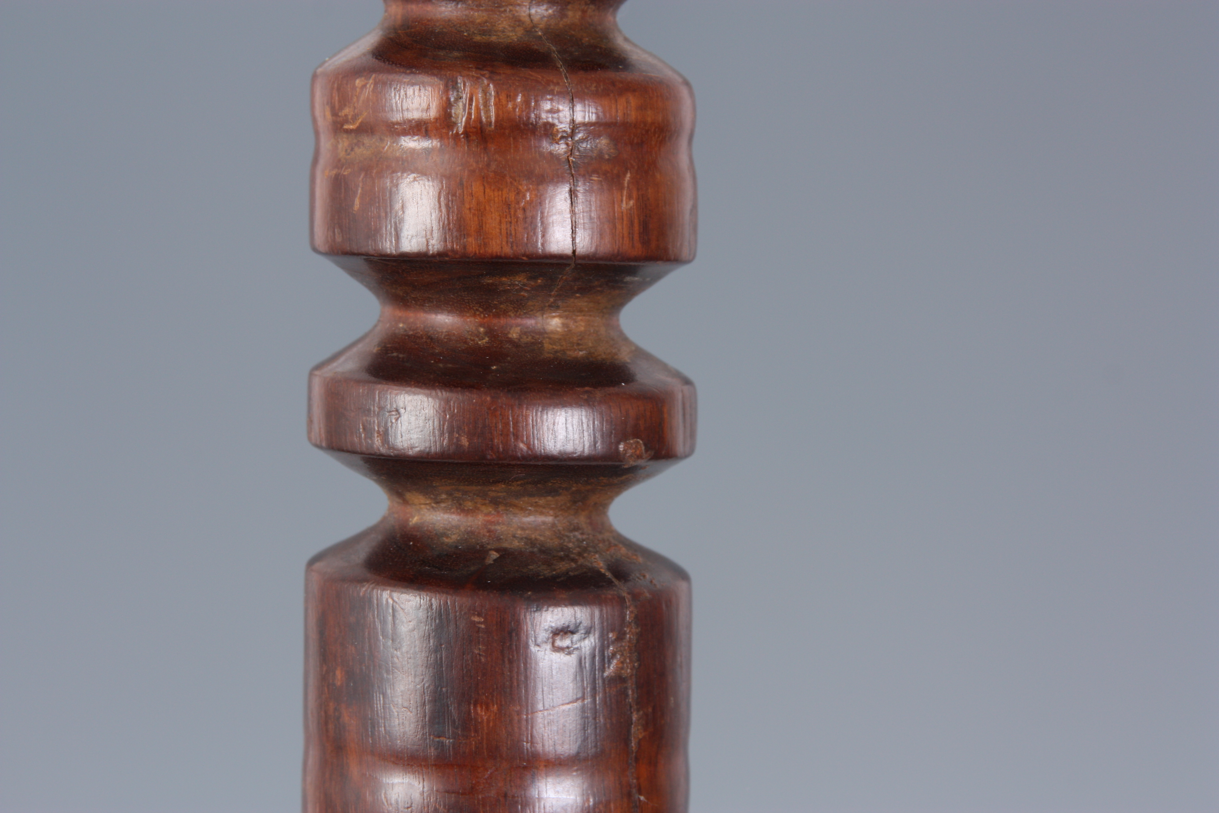 AN ANTIQUE AFRICAN HARDWOOD FIGHTING CLUB with turned shaft and notched ...