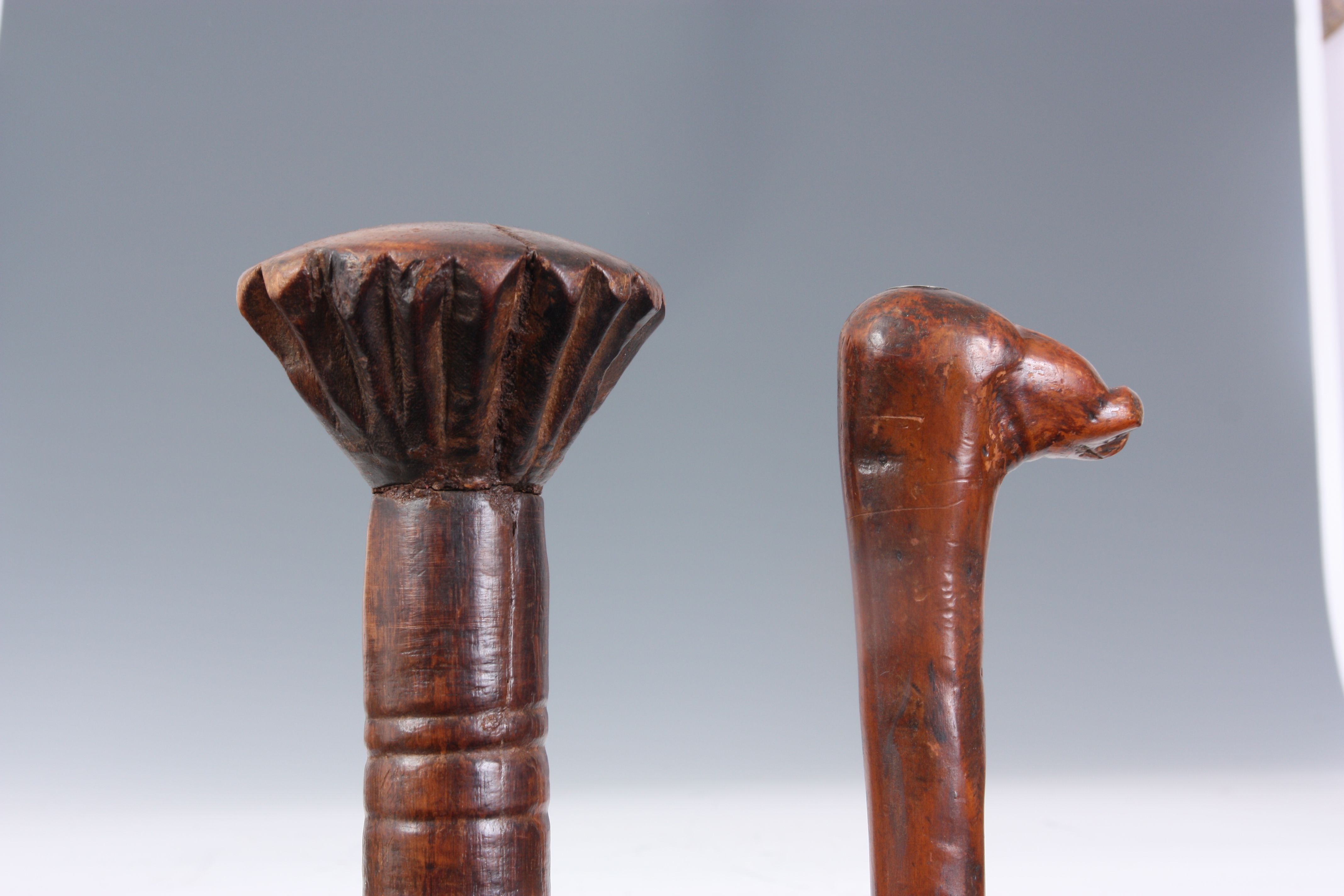 AN ANTIQUE AFRICAN HARDWOOD FIGHTING CLUB with turned shaft and notched ...
