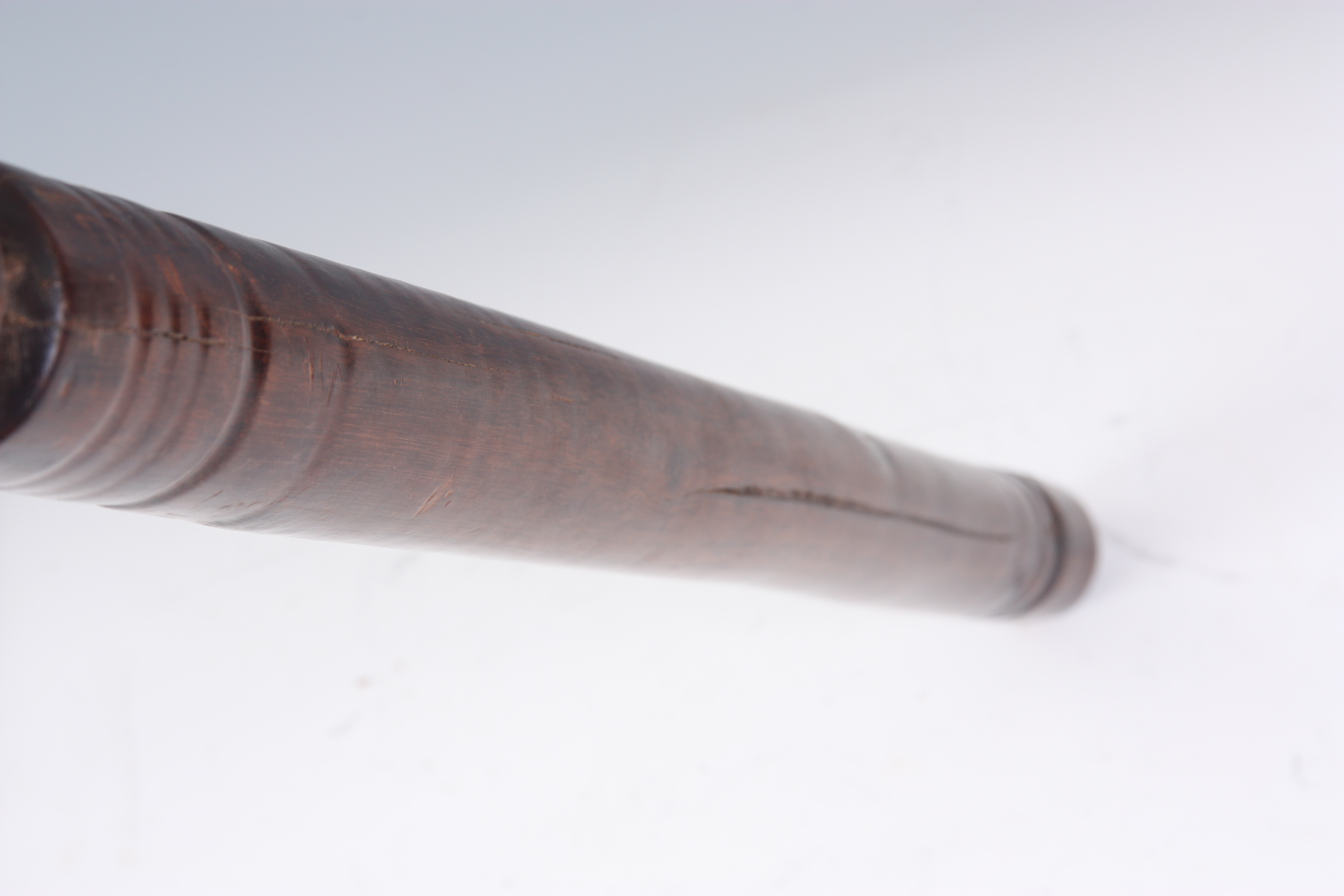 AN ANTIQUE AFRICAN HARDWOOD FIGHTING CLUB with turned shaft and notched ...