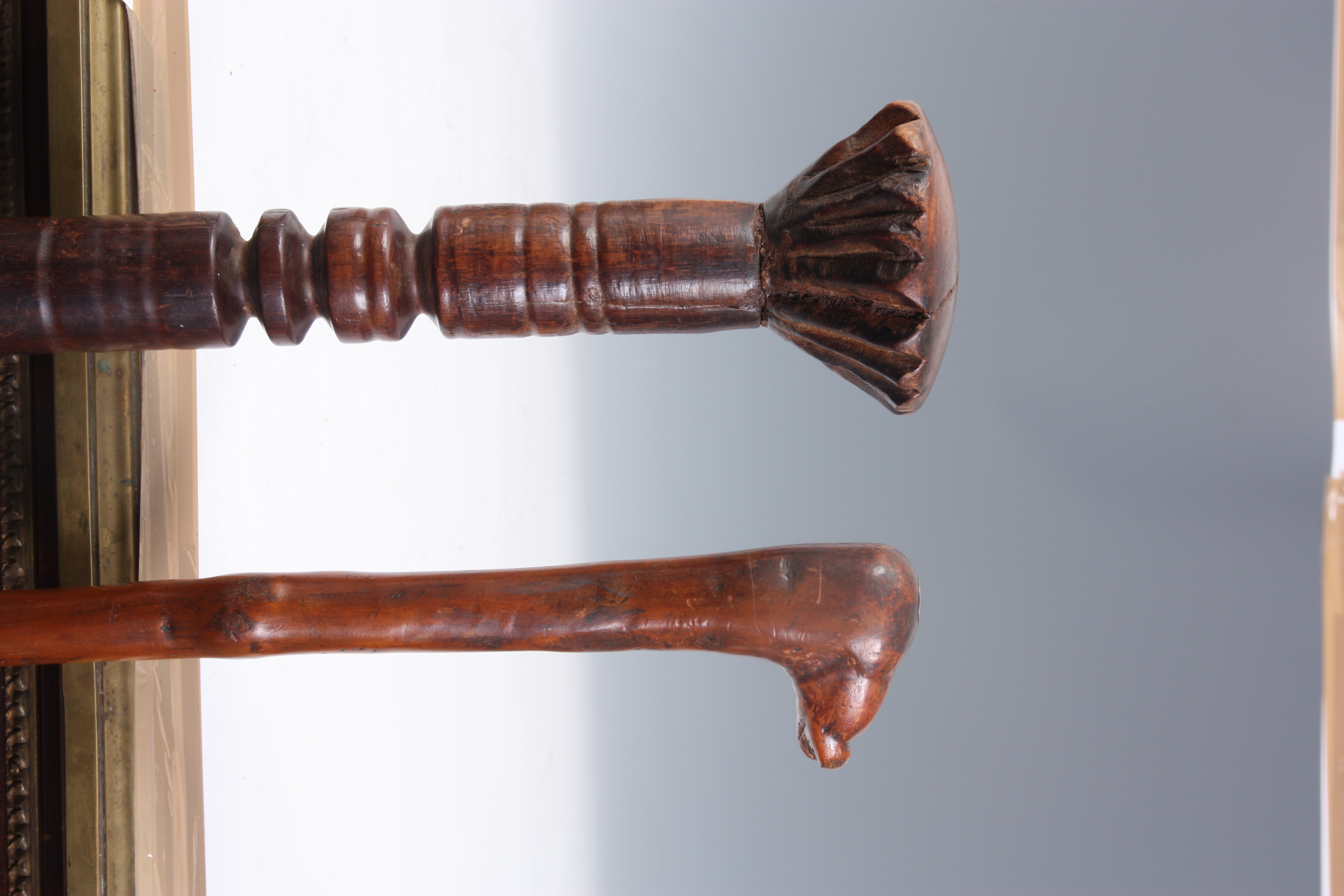 AN ANTIQUE AFRICAN HARDWOOD FIGHTING CLUB with turned shaft and notched ...