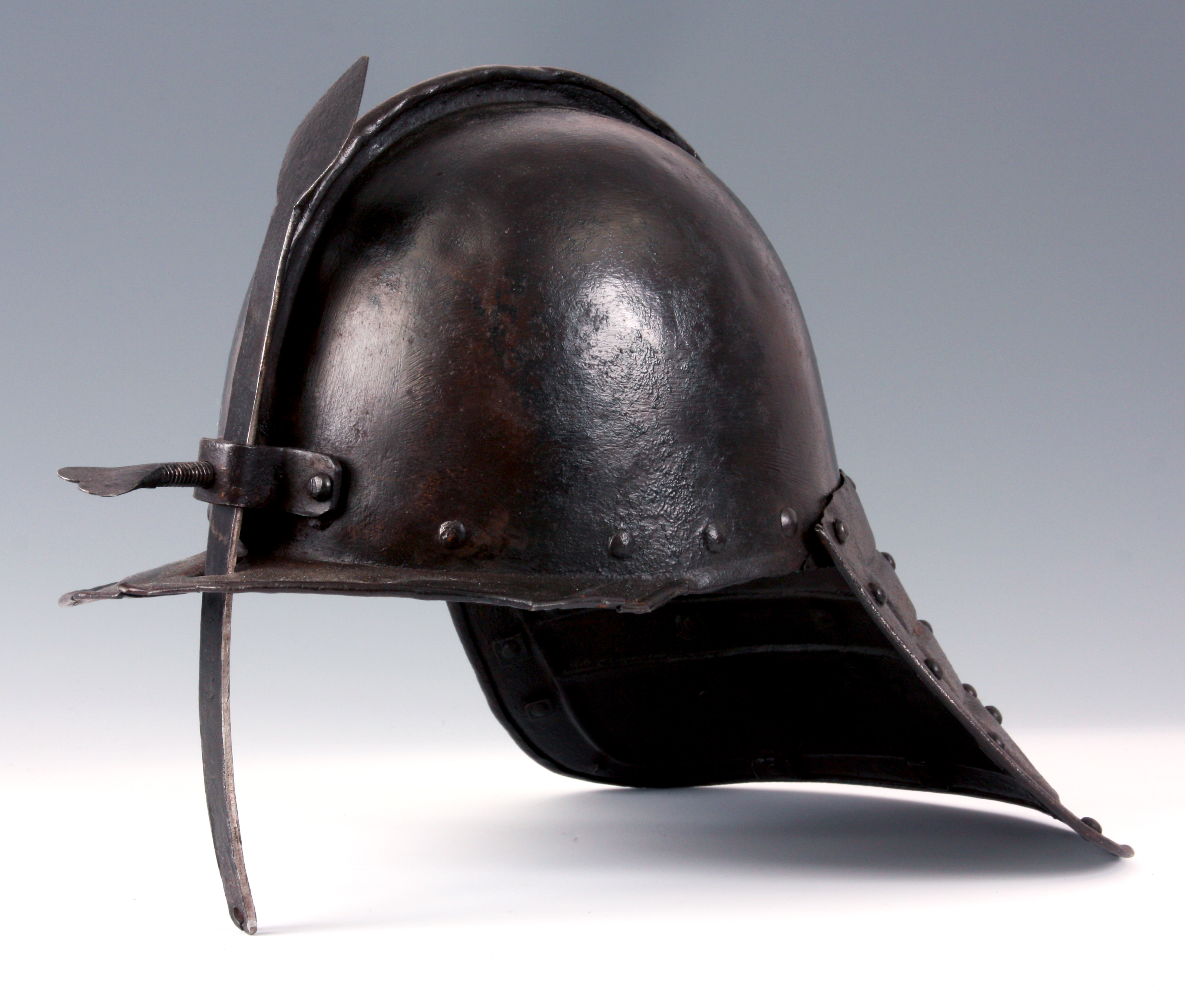 A LOBSTER TAILED HELMET with single nasal bar and two piece skull of ...