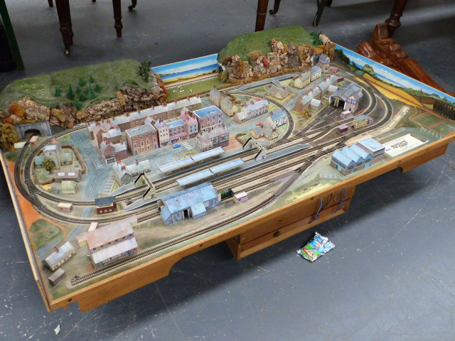 AN N GAUGE MODEL TRAIN LAYOUT COMPLETE WITH CONTROLLERS.