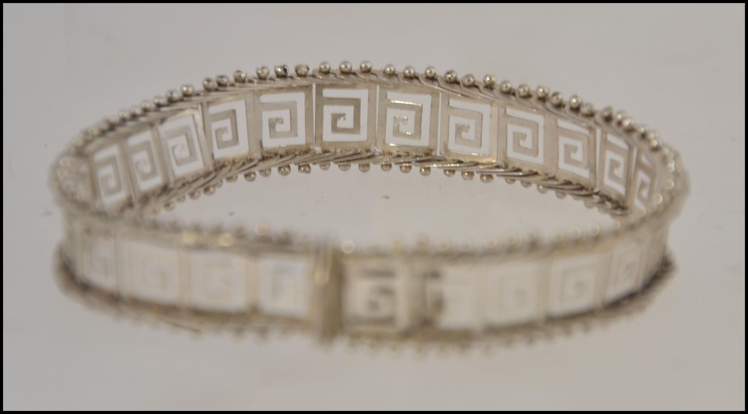A 925 silver bracelet of Greek key design stamped to the clasp 925 and ...