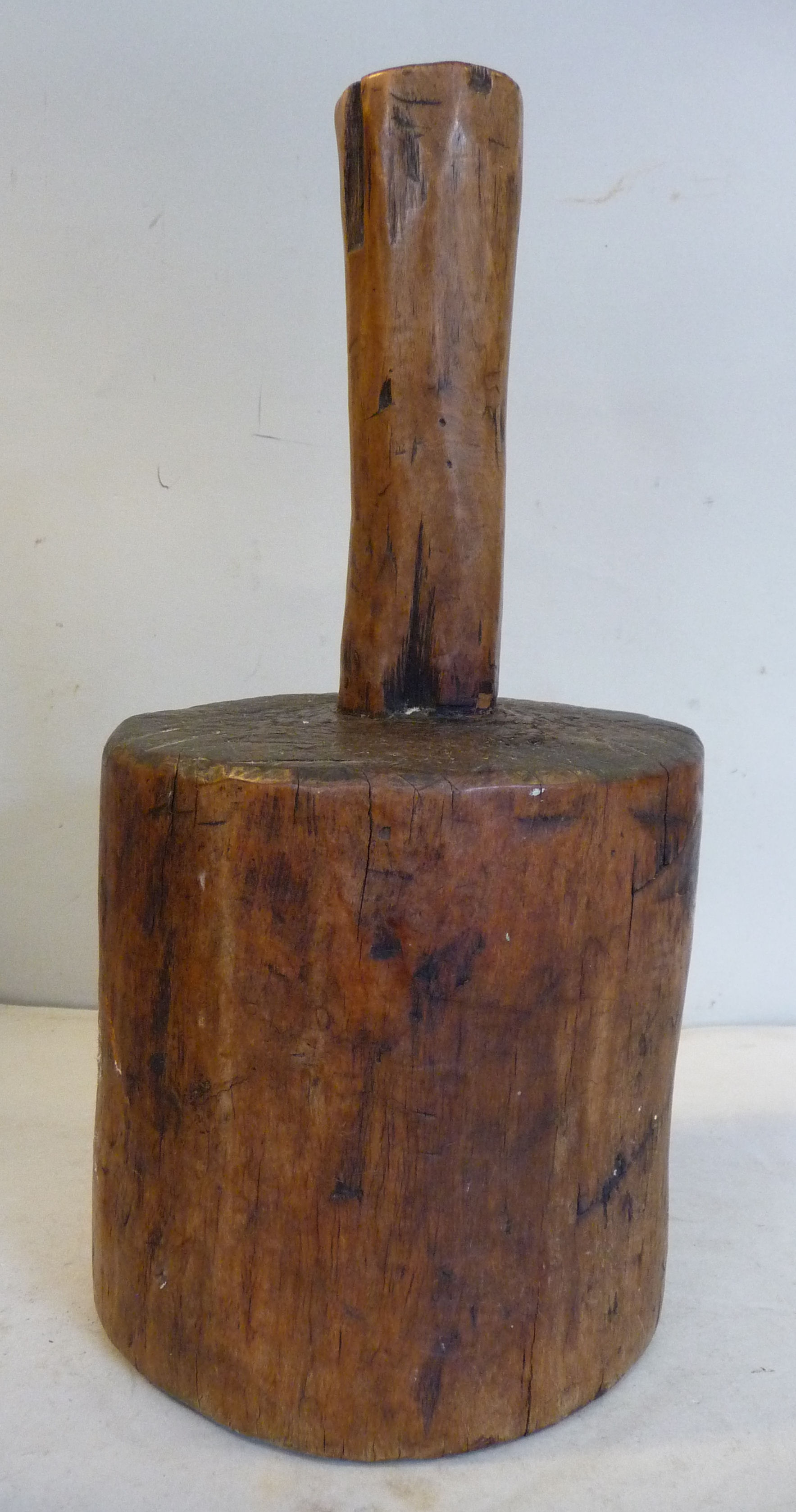 A Japanese 'antique' rustically carved one-piece wooden mallet with a ...