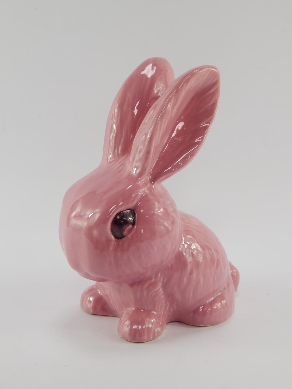 A Sylvac pink glazed seated rabbit, impressed marks, 21cm high.